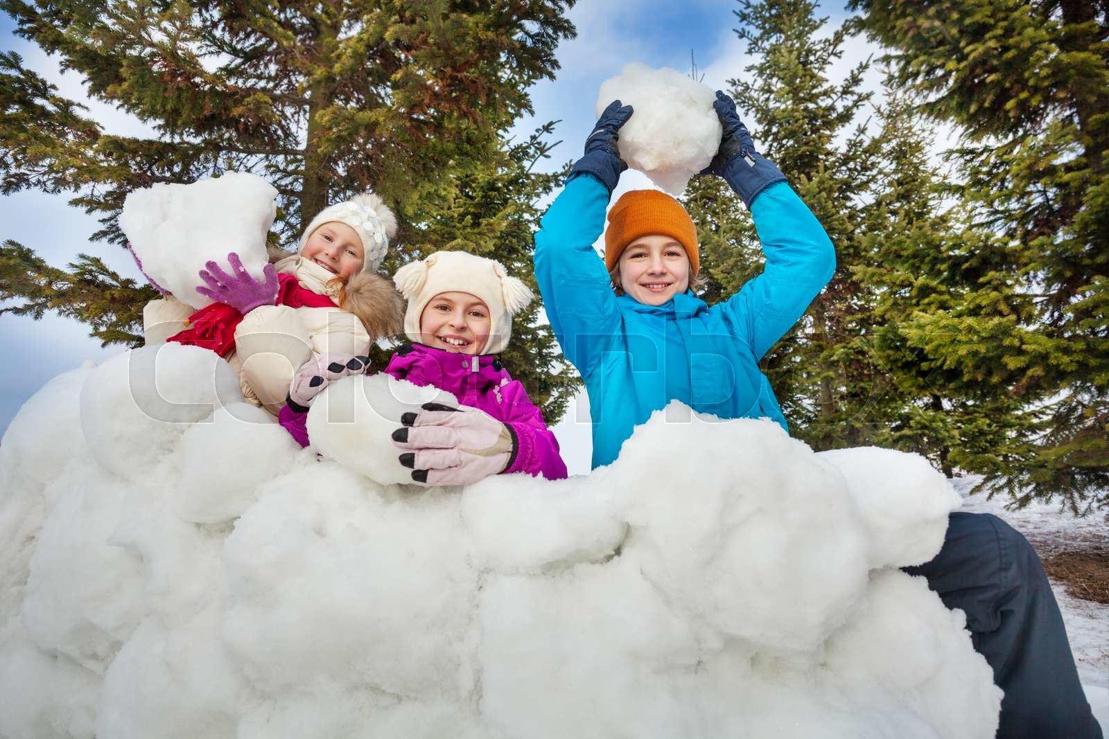 Group of happy children hold snowballs to play | Stock image | Colourbox