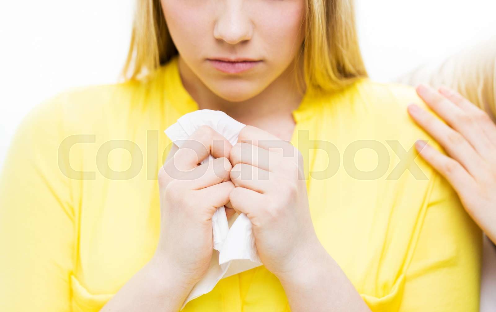 close up of crying teenage girl and friend hand | Stock image | Colourbox