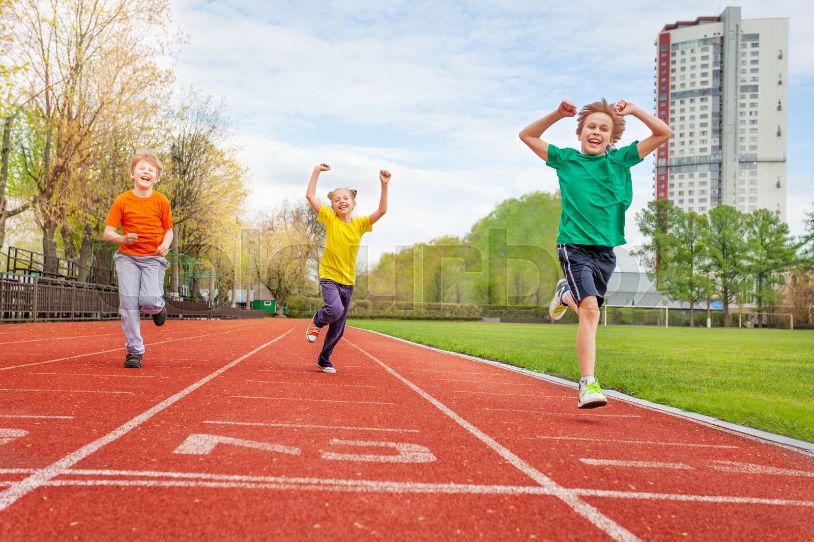 Group of happy kids on stadium | Stock image | Colourbox