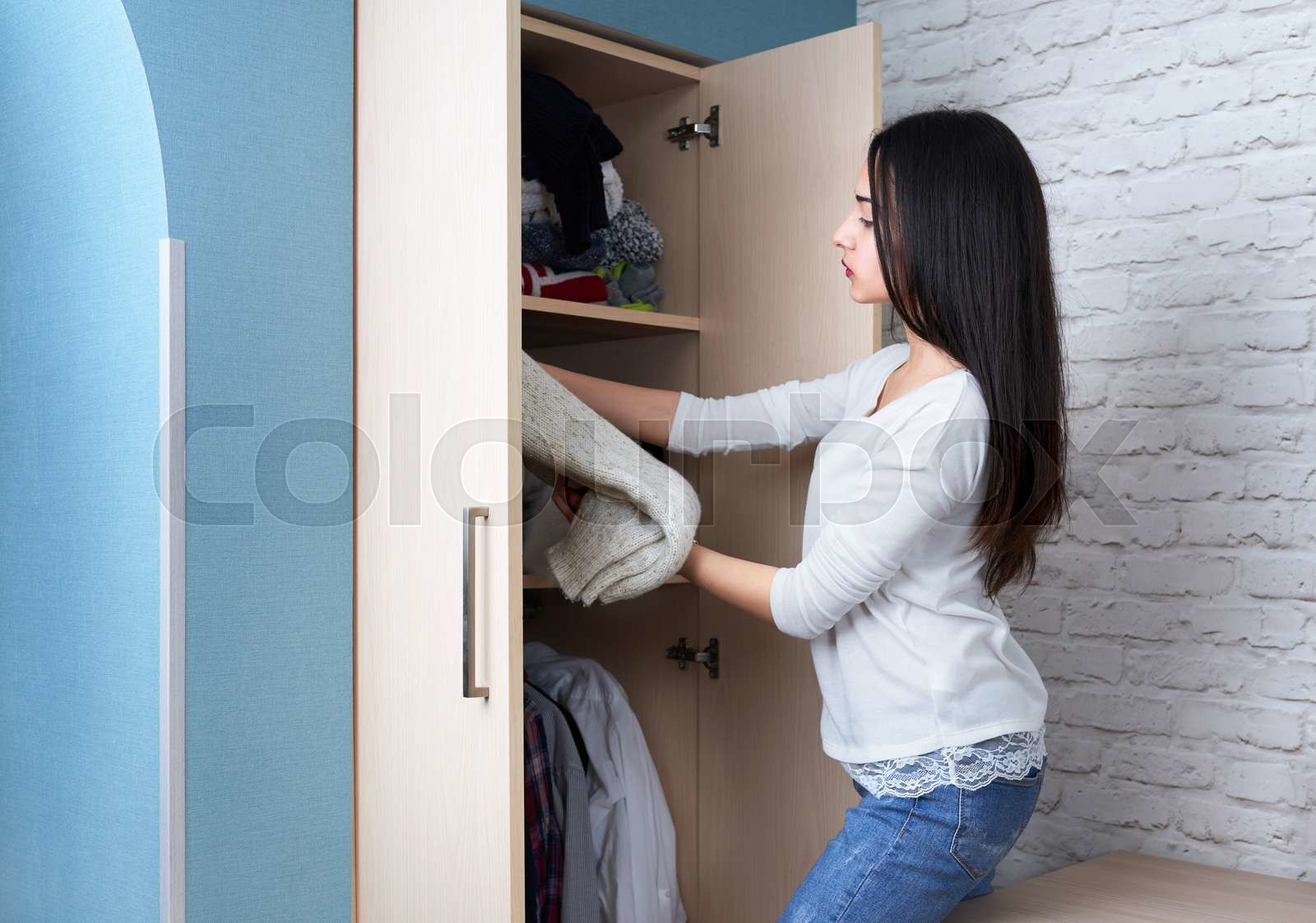 girl gets clothes with wardrobe | Stock image | Colourbox