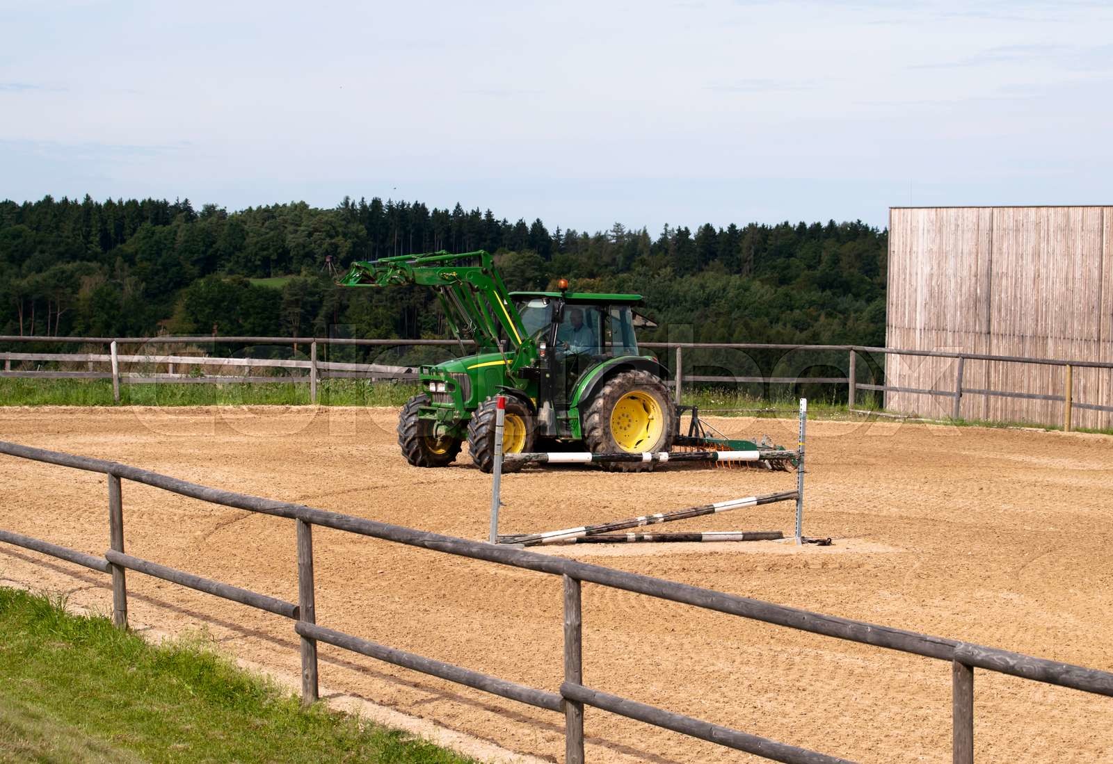 Preparing arena for showjumping | Stock image | Colourbox