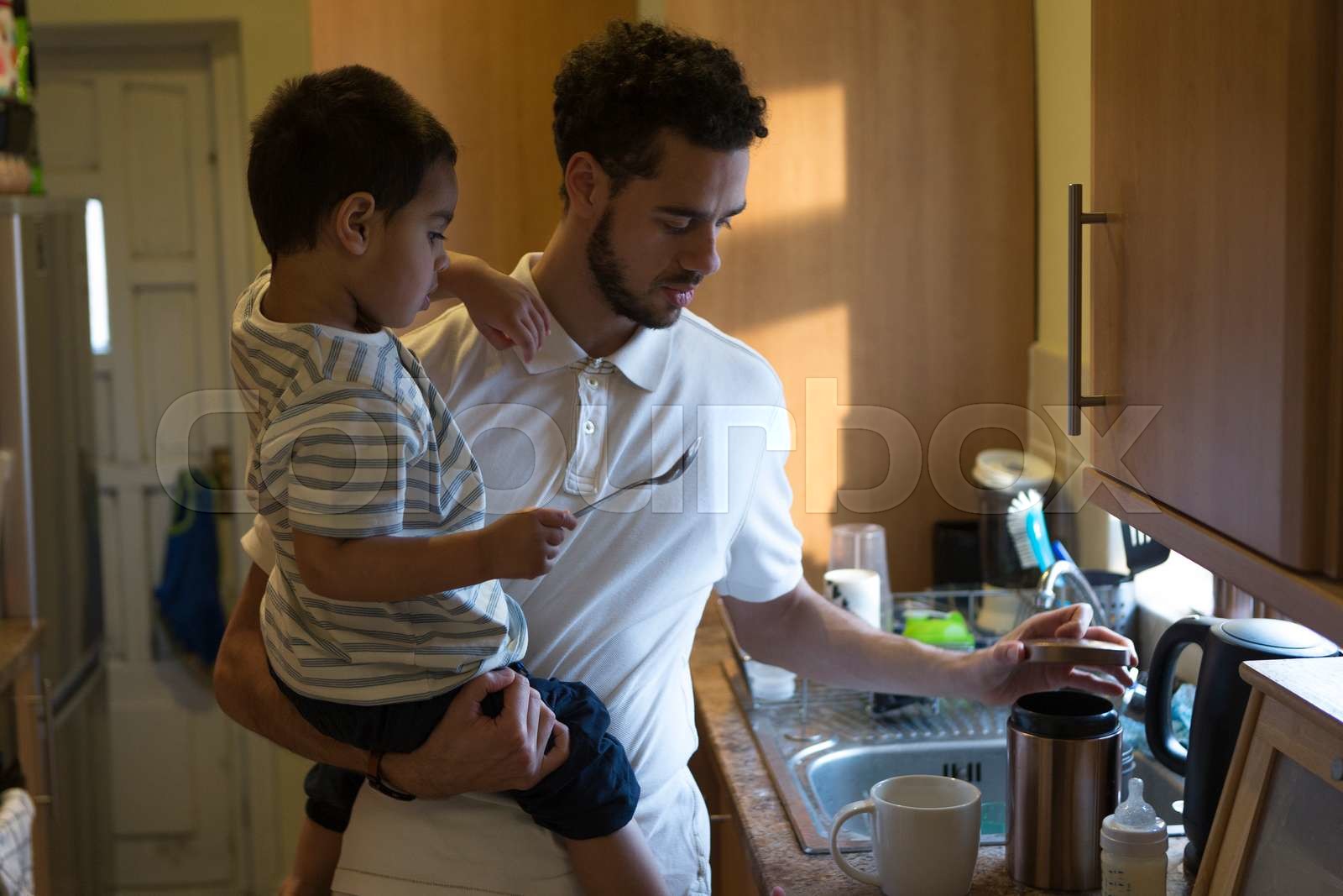 Helping daddy make tea | Stock image | Colourbox