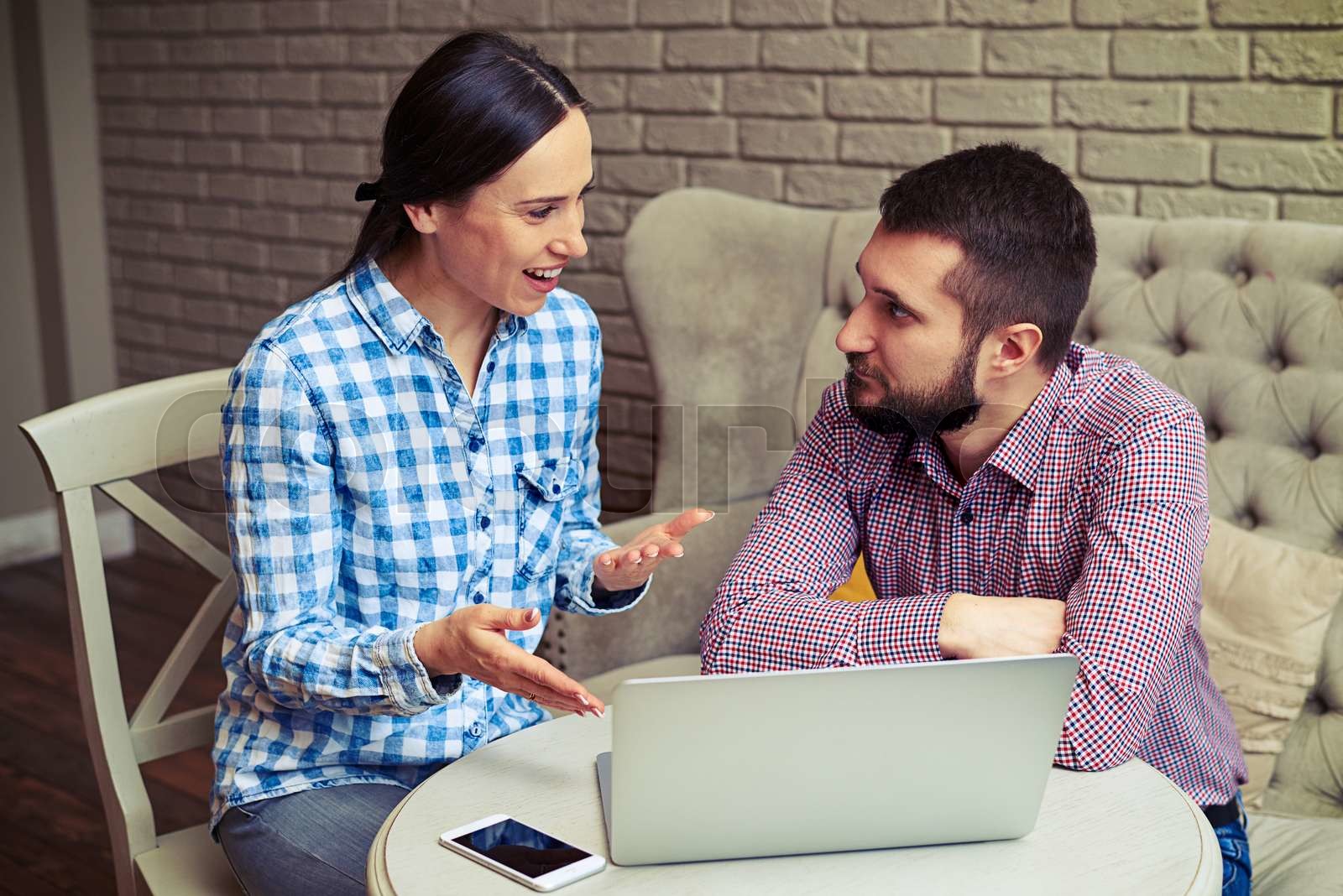 woman explaining something to serious handsome man | Stock image ...