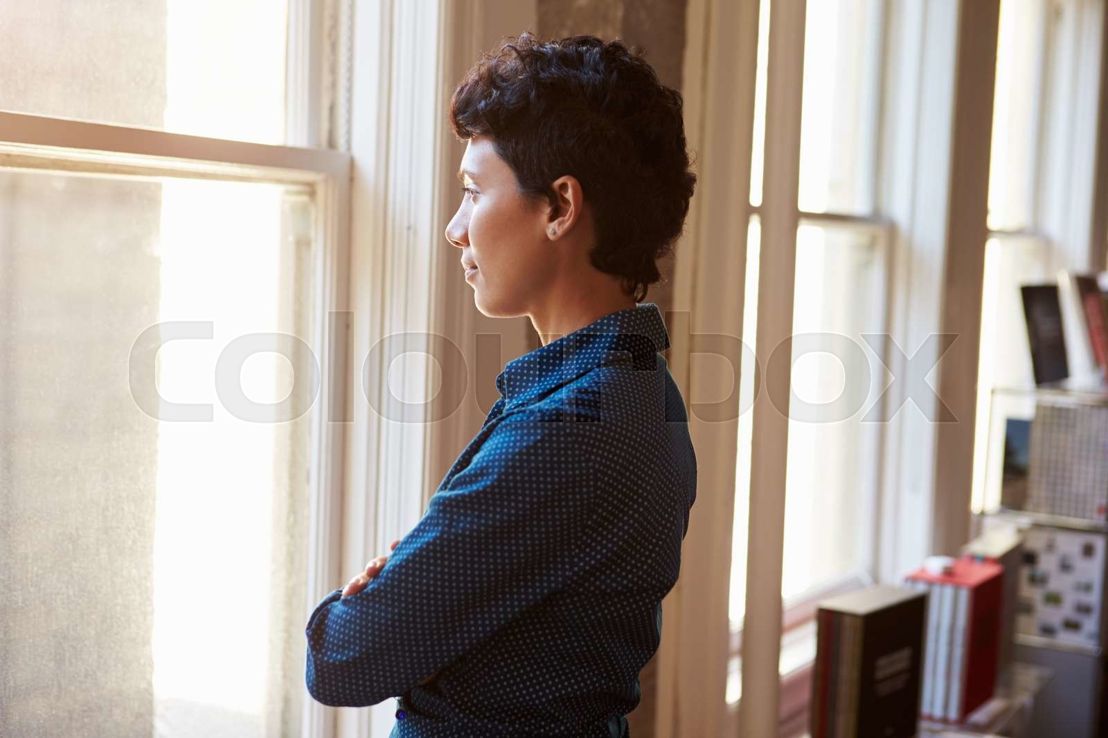 Businesswoman Looking Out Of Office Window | Stock image | Colourbox