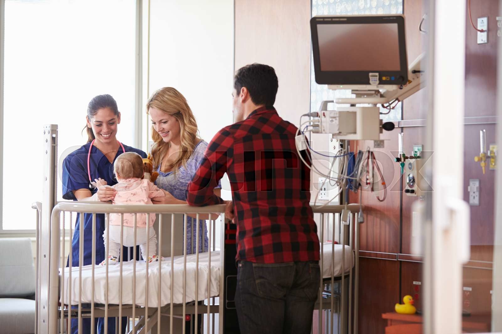 Pediatrician Visiting Parents And Child In Hospital Bed | Stock image ...