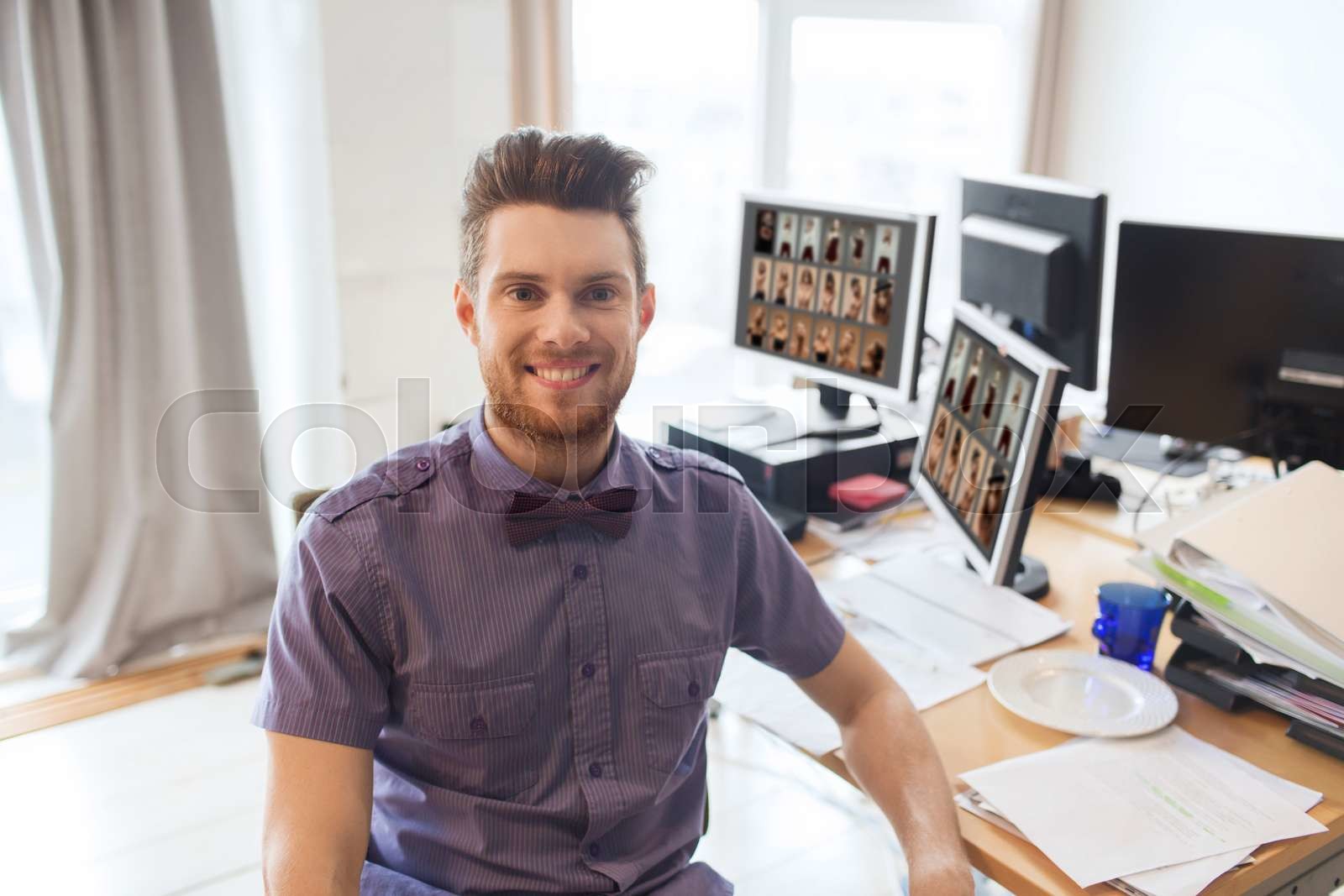 happy creative male office worker with computers | Stock image | Colourbox