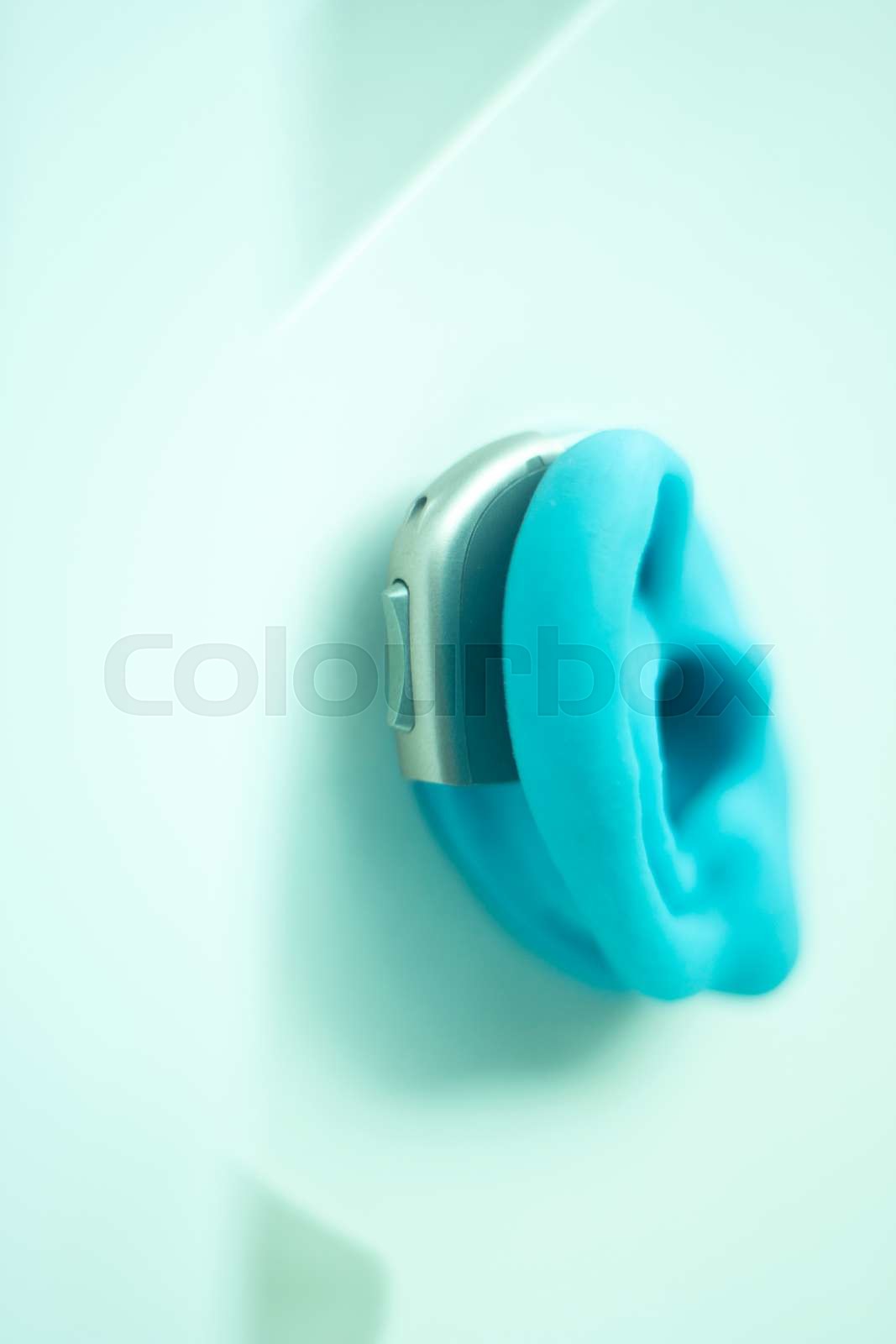 Hearing aid on prosthetic ear | Stock image | Colourbox
