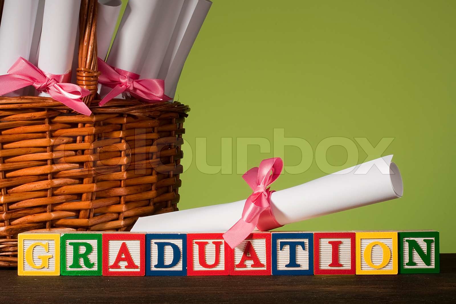 Diploma tied with a ribbon, the text of the wooden blocks "Graduation ...