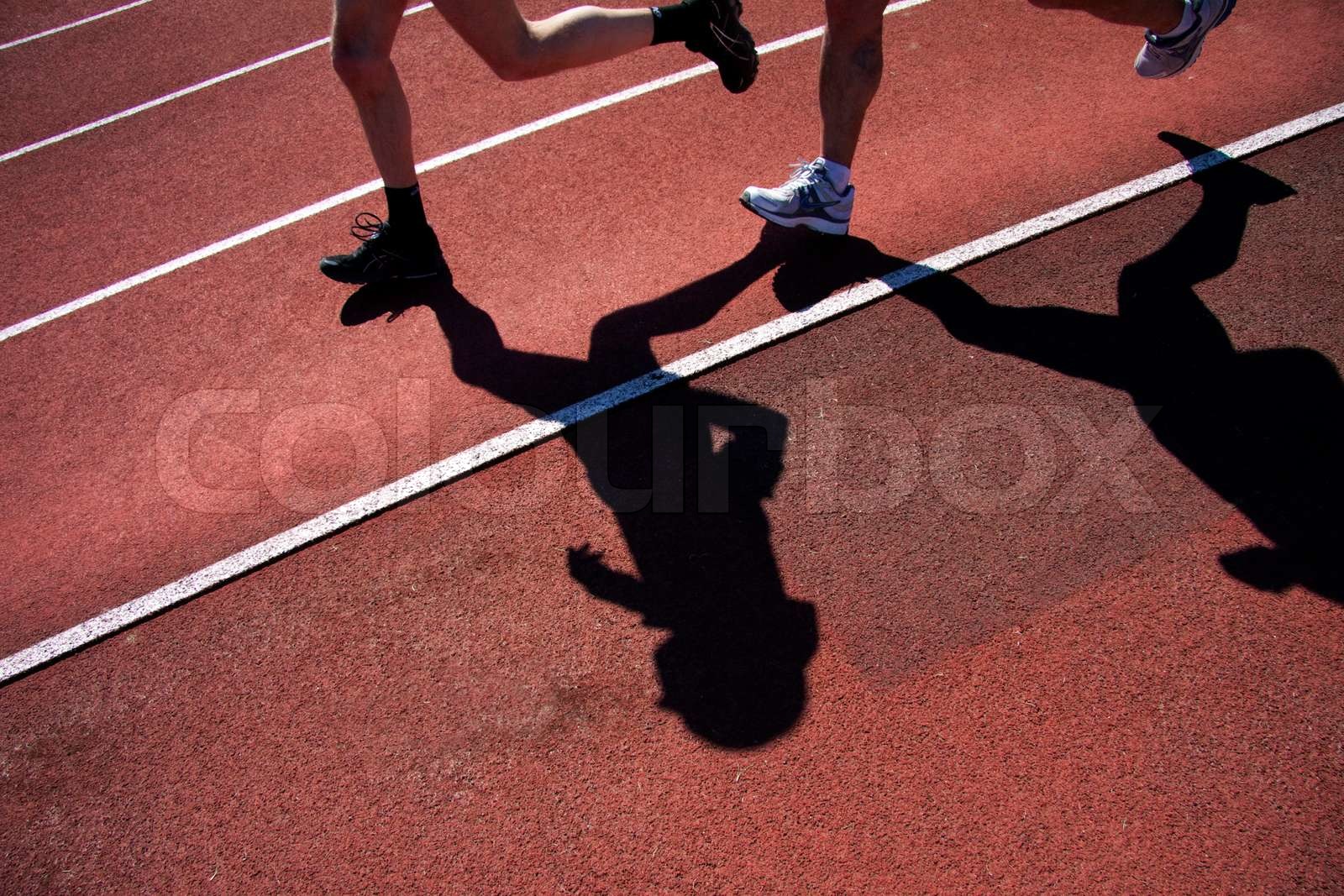 Marathon runners legs and shadows | Stock image | Colourbox