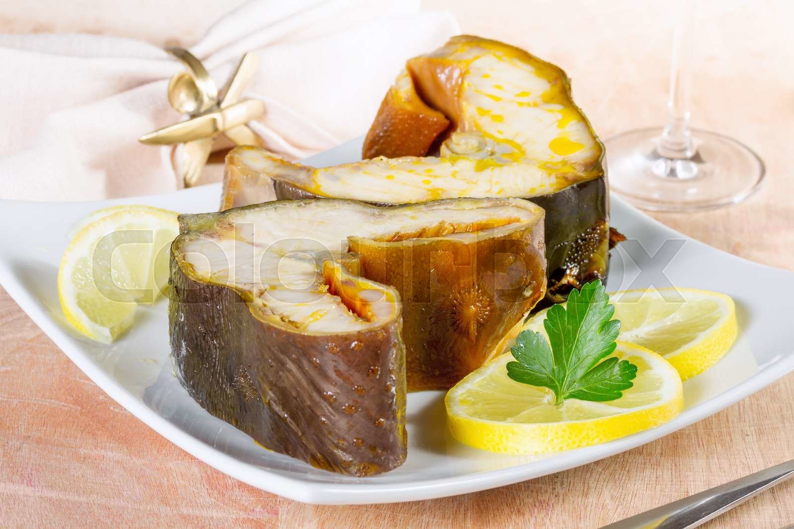 Smoked sturgeon fillet on a platter | Stock image | Colourbox