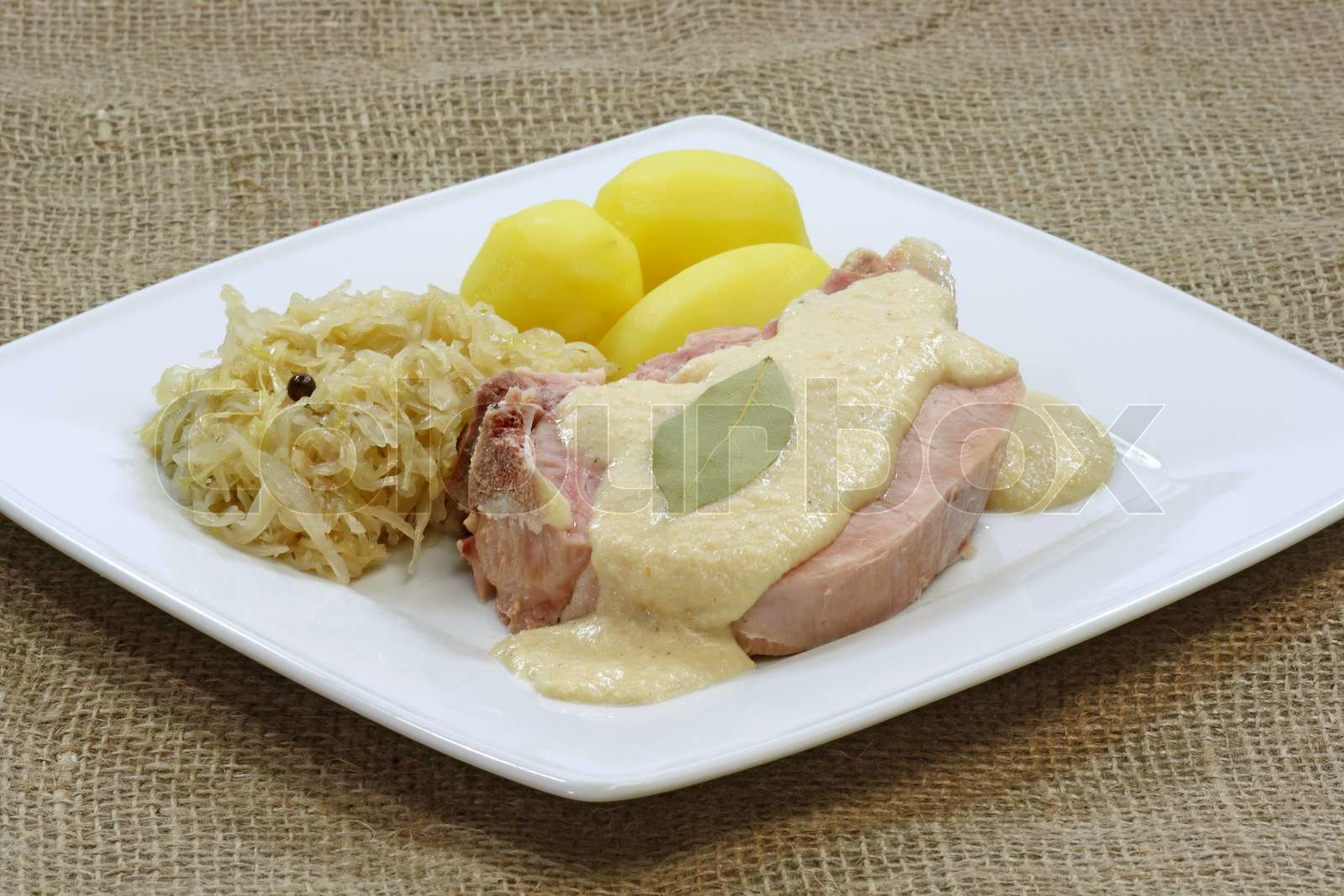 Traditional german pork meat with sauerkraut and potatoes | Stock image ...