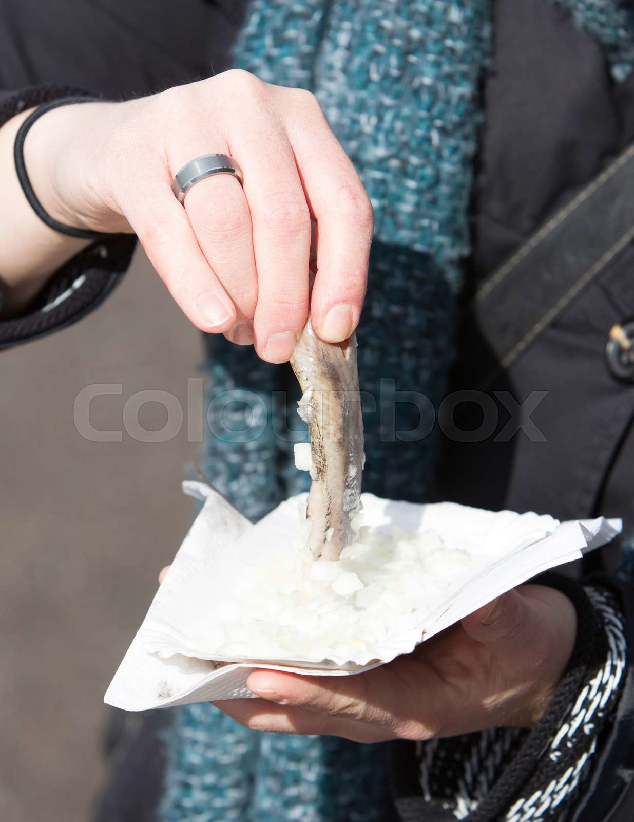 Dutch woman is eating typical raw herring | Stock image | Colourbox