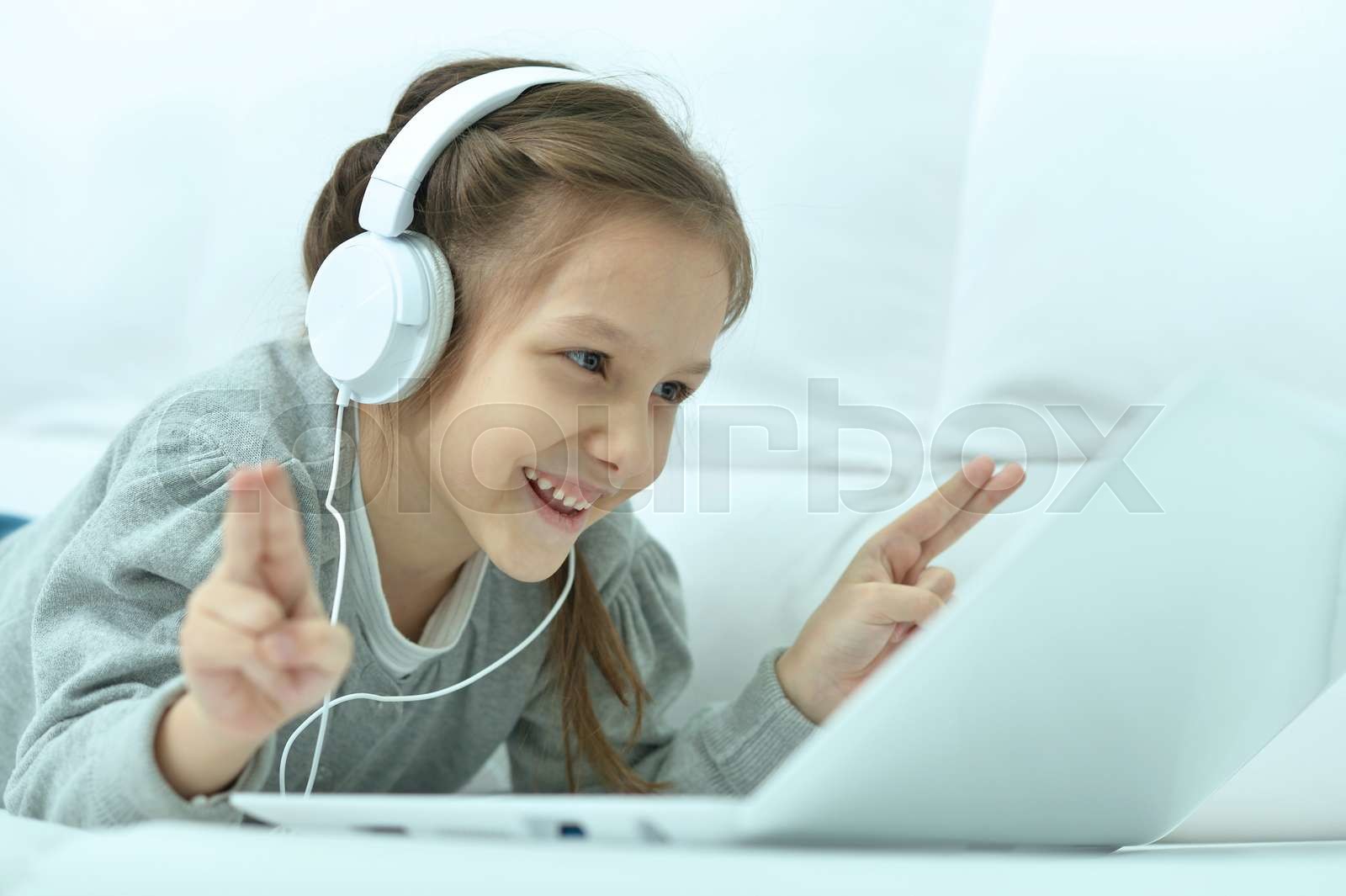 smiling little girl with laptop computer | Stock image | Colourbox