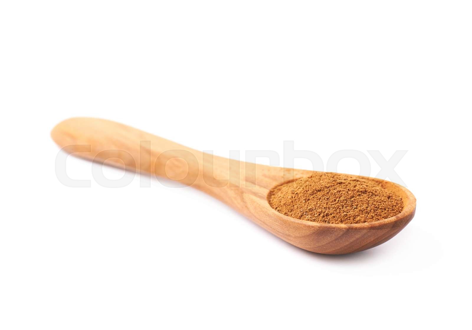 Wooden spoon full of cinnamon | Stock image | Colourbox