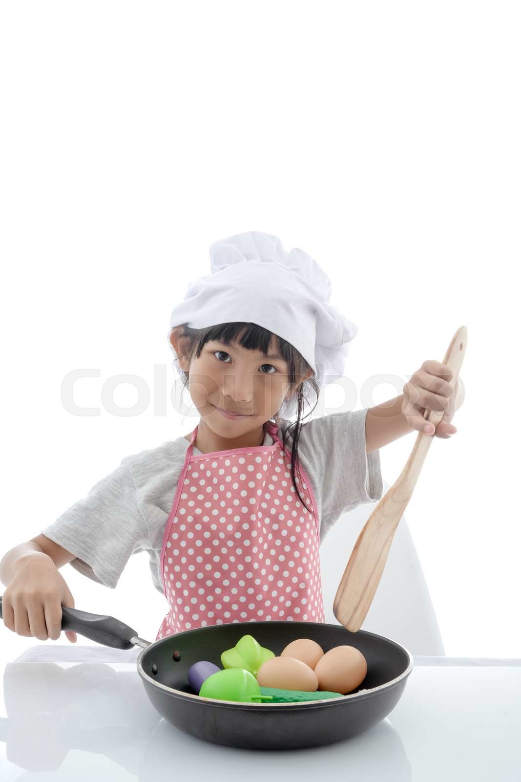 Asian girl cooking at home | Stock image | Colourbox