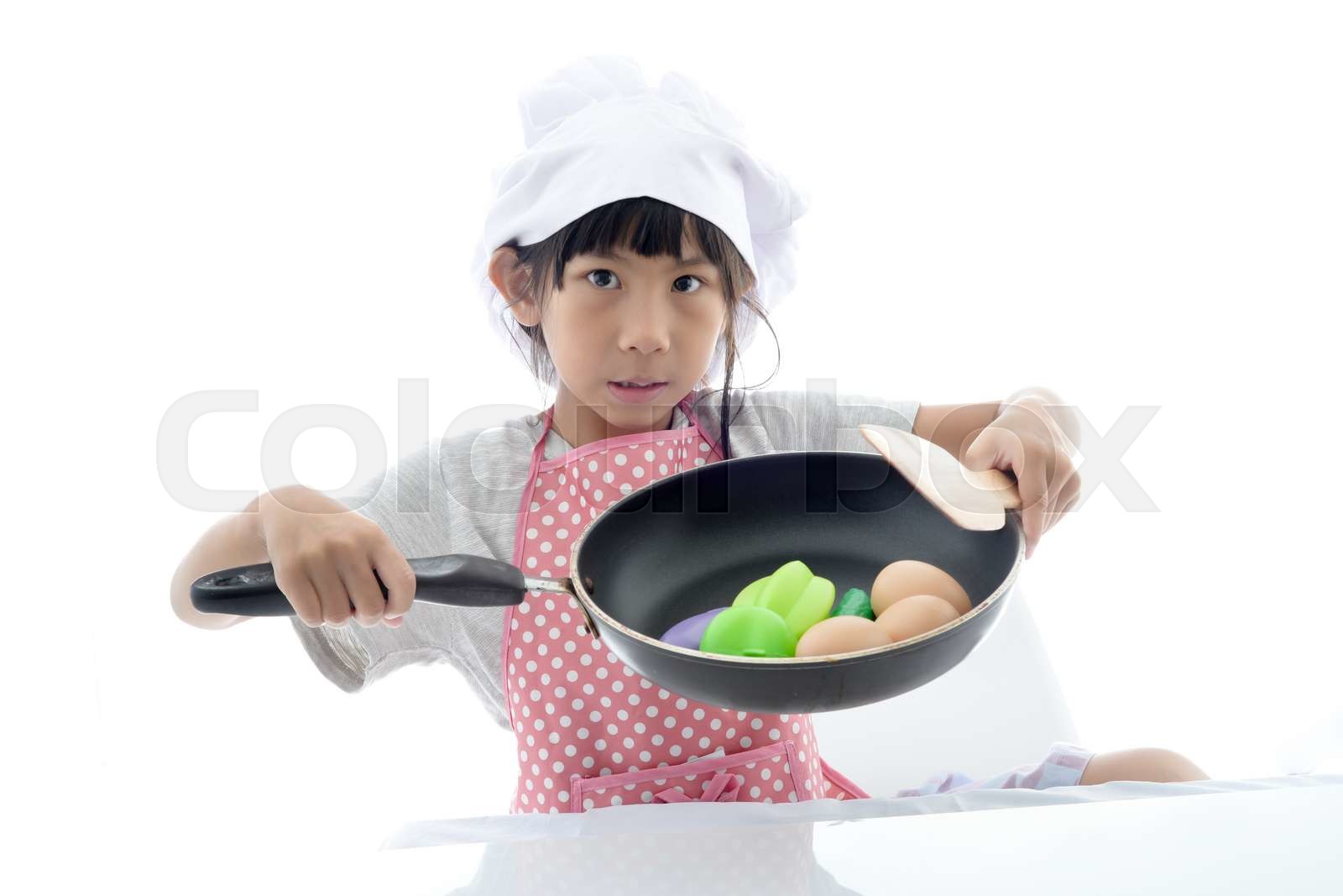 Asian girl cooking at home | Stock image | Colourbox