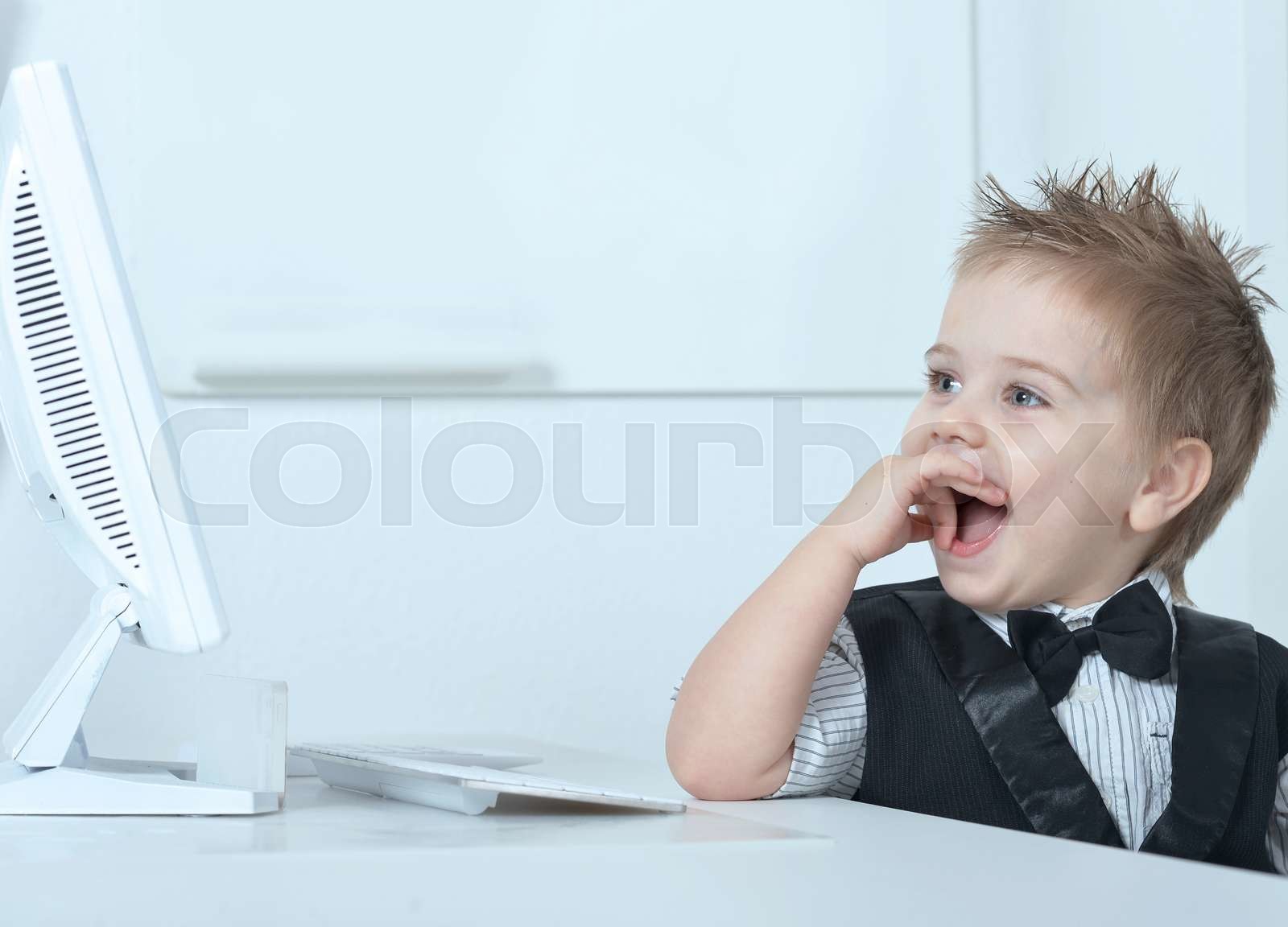 cute Little boy with computer | Stock image | Colourbox