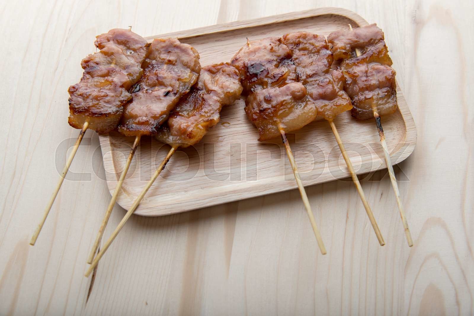 grilling pork with stick | Stock image | Colourbox