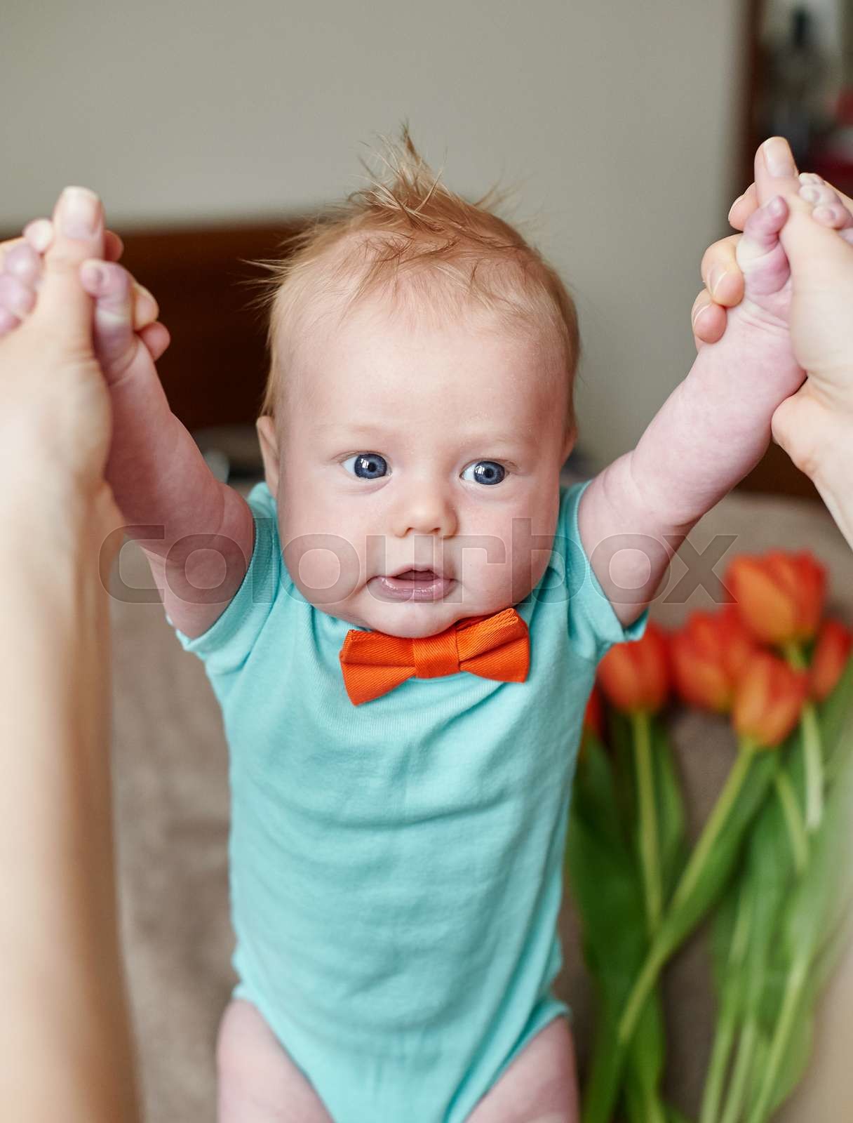 Mother teaching her cute little son to walk holding hands body part ...