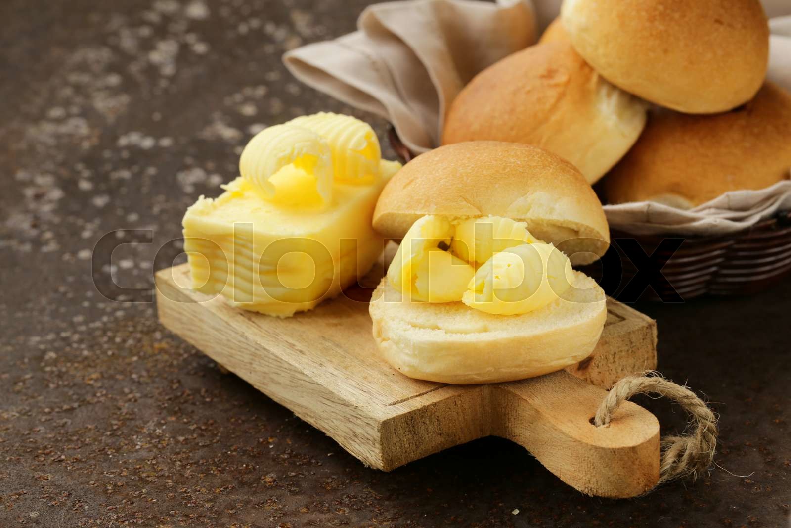 yellow dairy butter on a fresh bun | Stock image | Colourbox