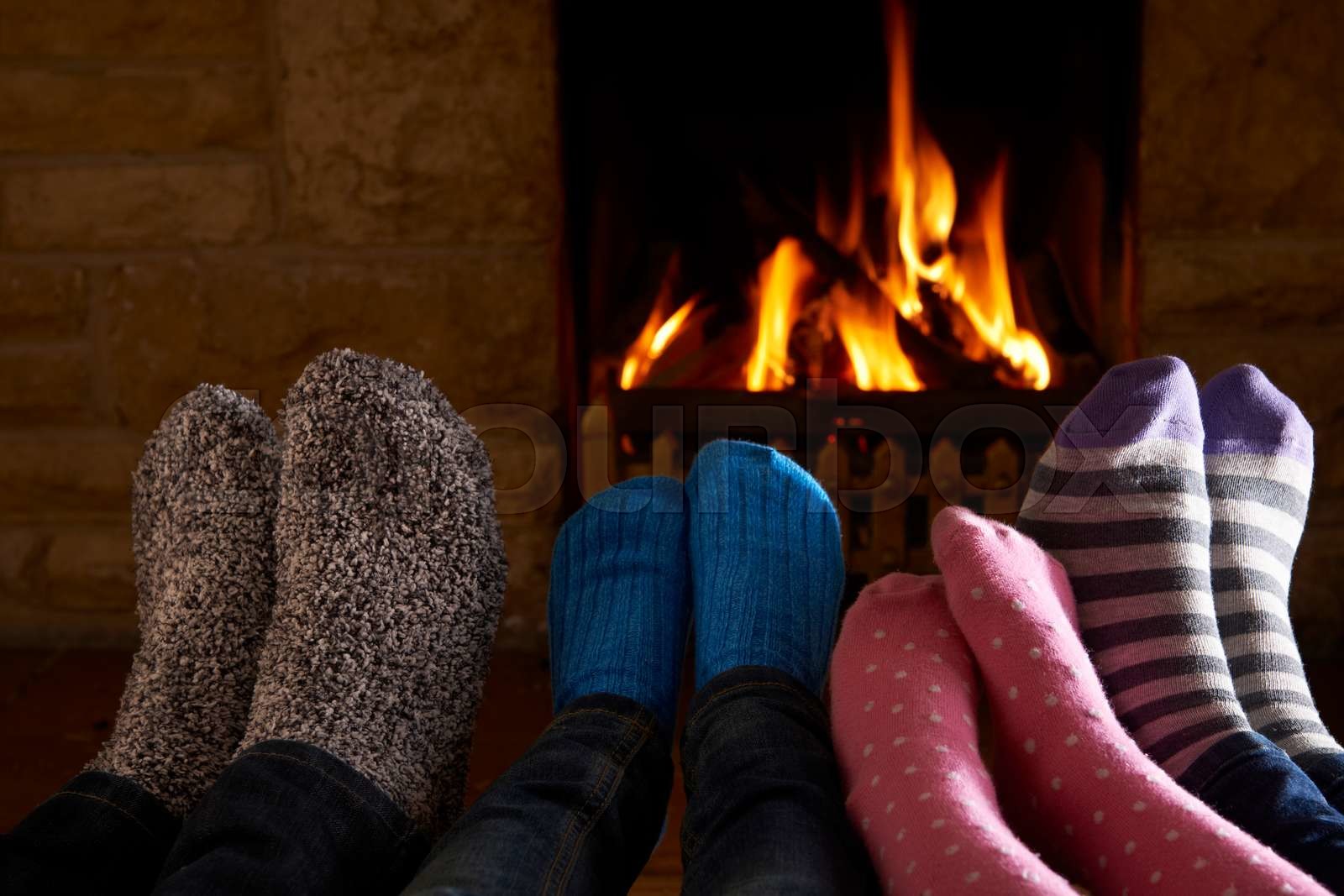 Family Warming Feet By Fire | Stock image | Colourbox