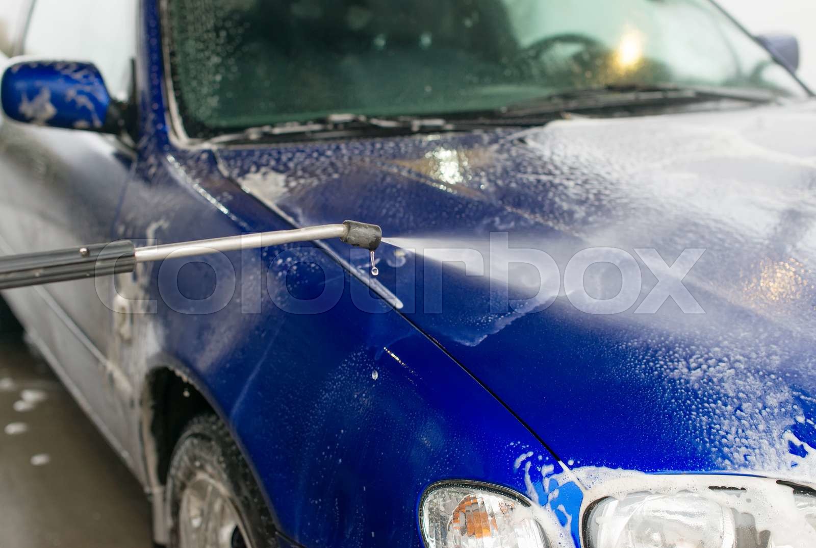 Car wash using high pressure water jet. | Stock image | Colourbox