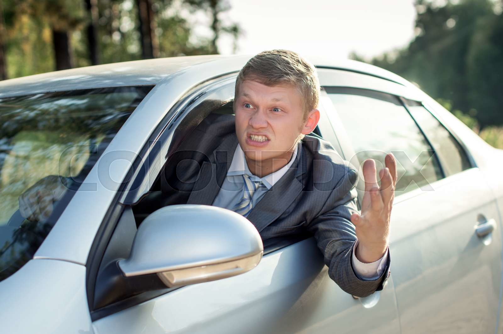 Aggressive driver complains while driving | Stock image | Colourbox