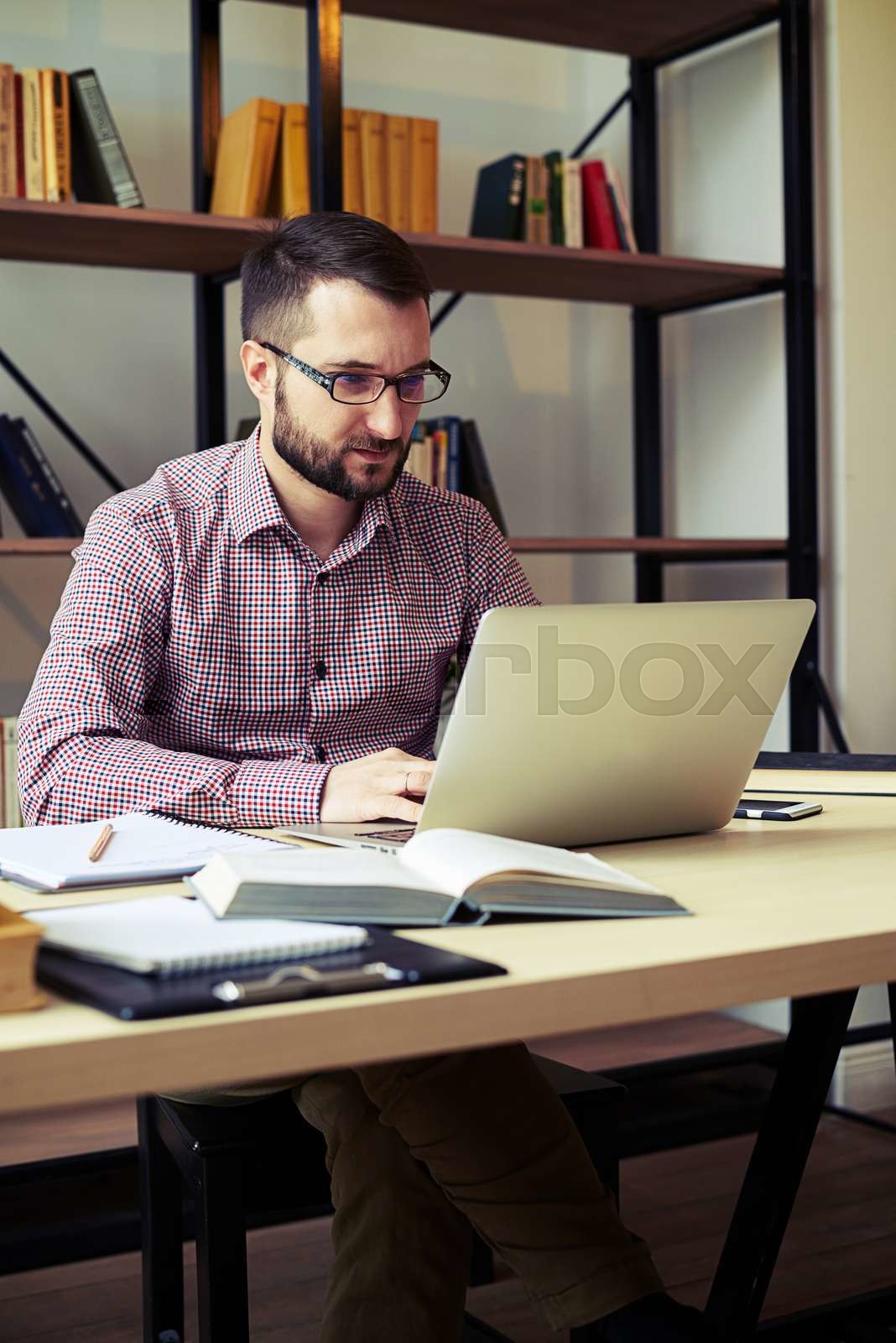Man with the glasses looking at his laptop and typing | Stock image ...