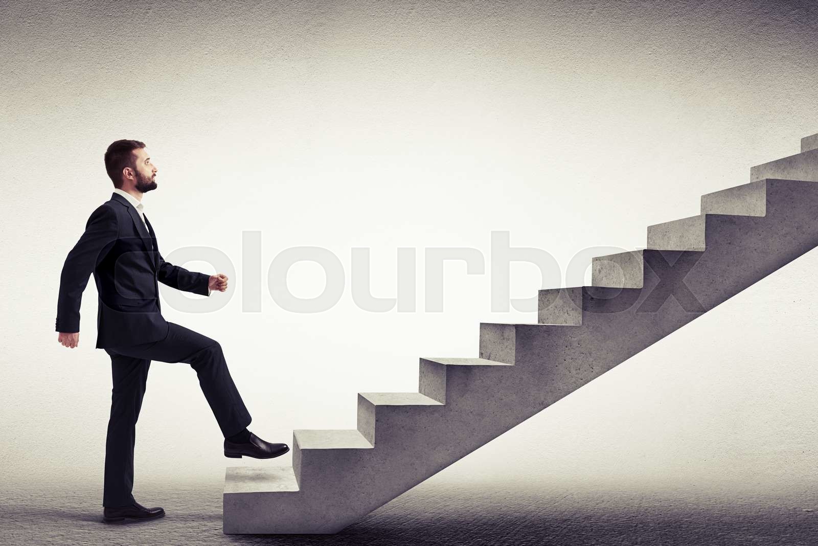 Side view of a man in a formal wear climbing concrete stairs | Stock ...