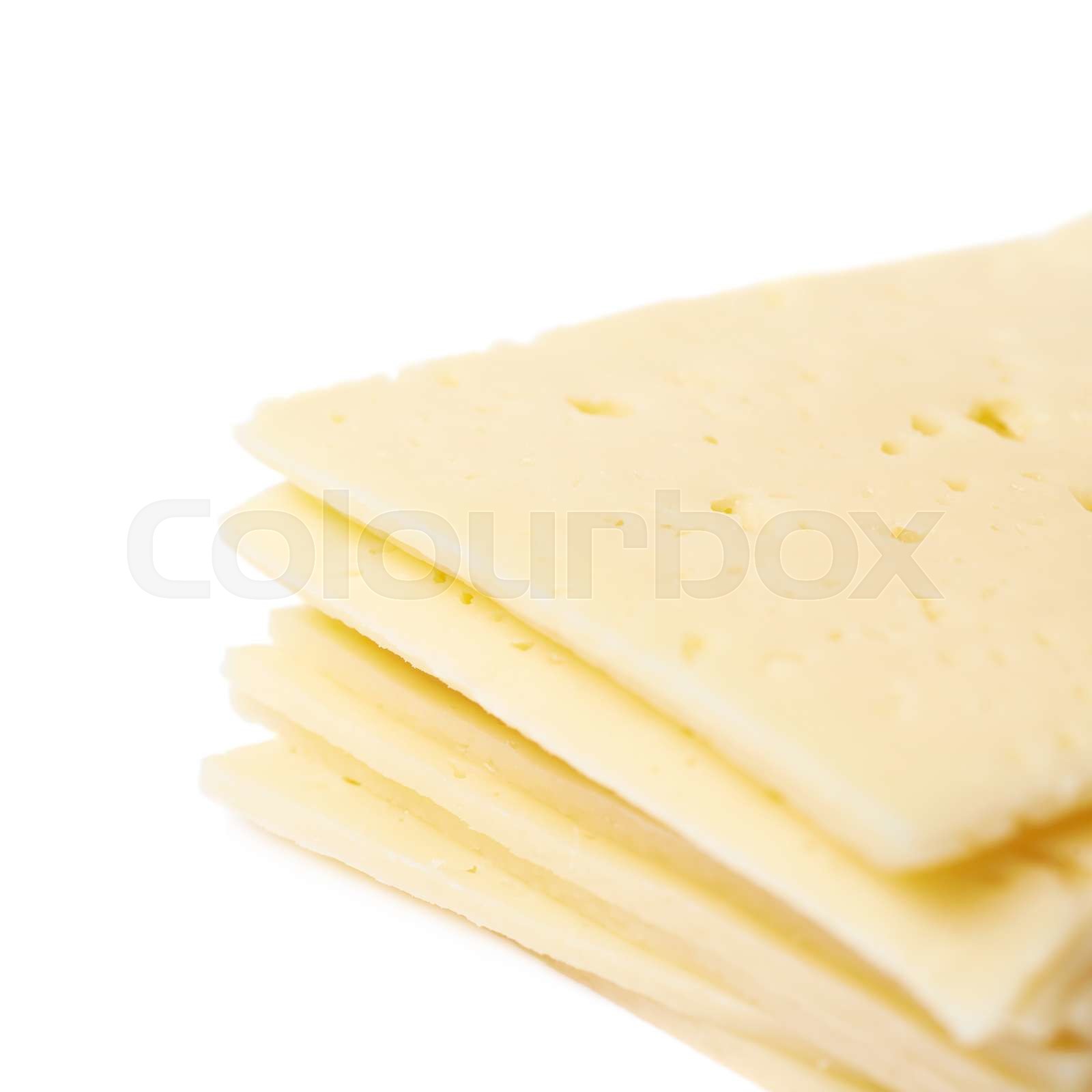 Pile of cheese slices isolated | Stock image | Colourbox