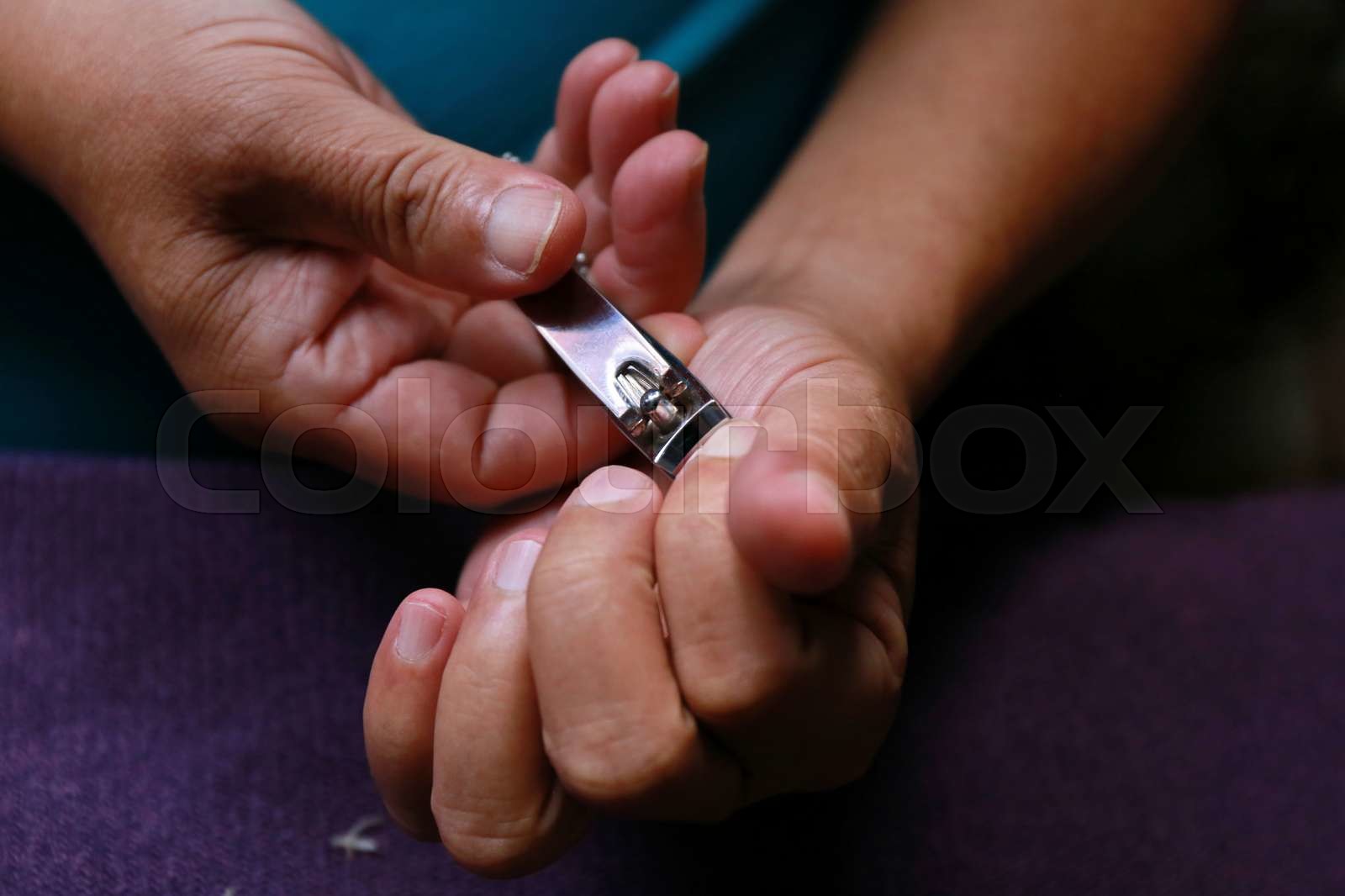 Man's hand cutting nails | Stock image | Colourbox