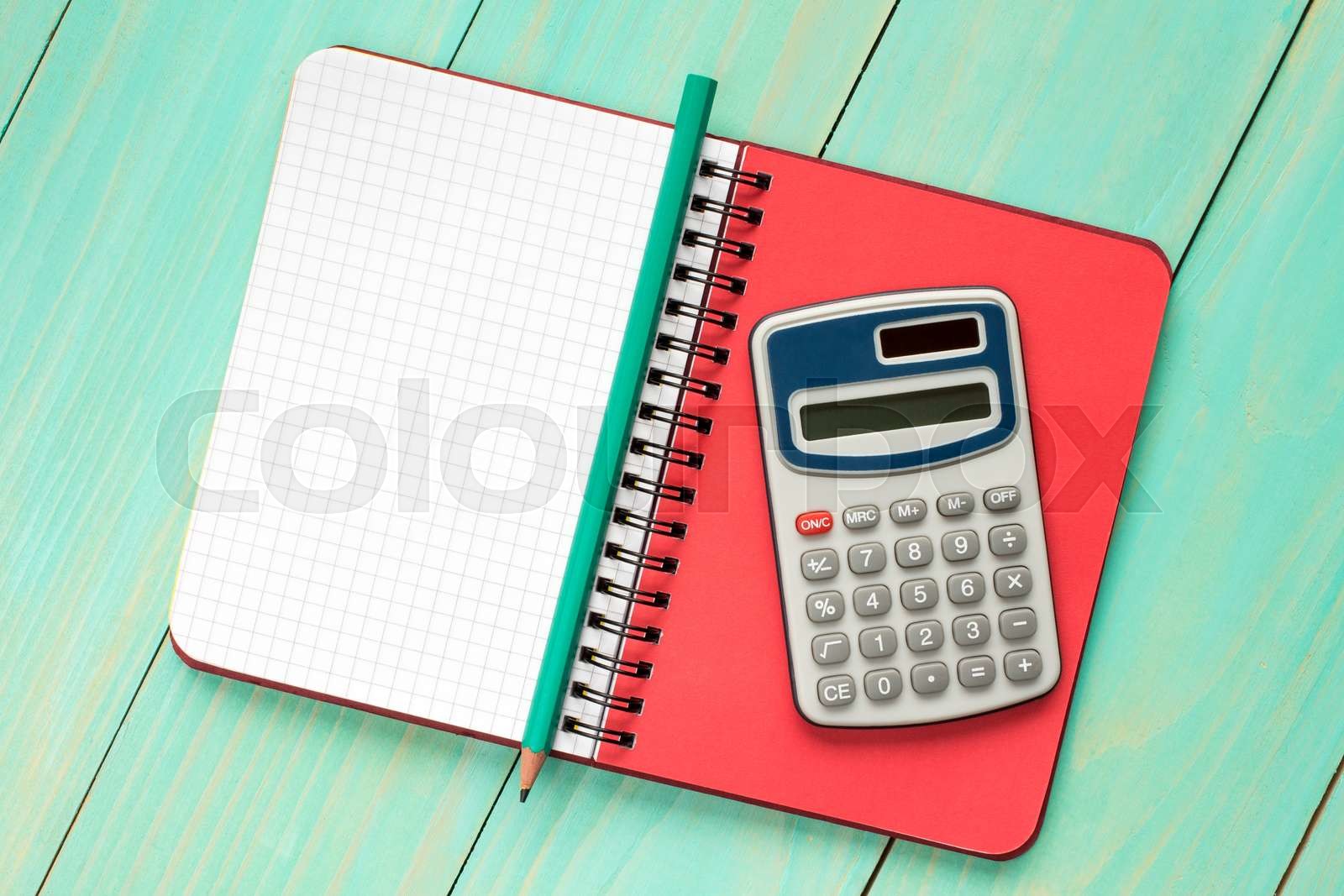 Electronic calculator and notebook. | Stock image | Colourbox
