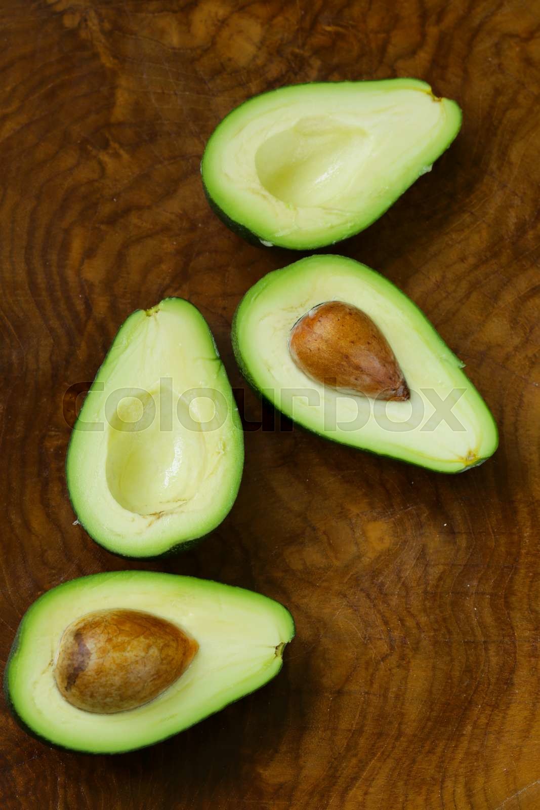 ripe organic avocado cut in half | Stock image | Colourbox