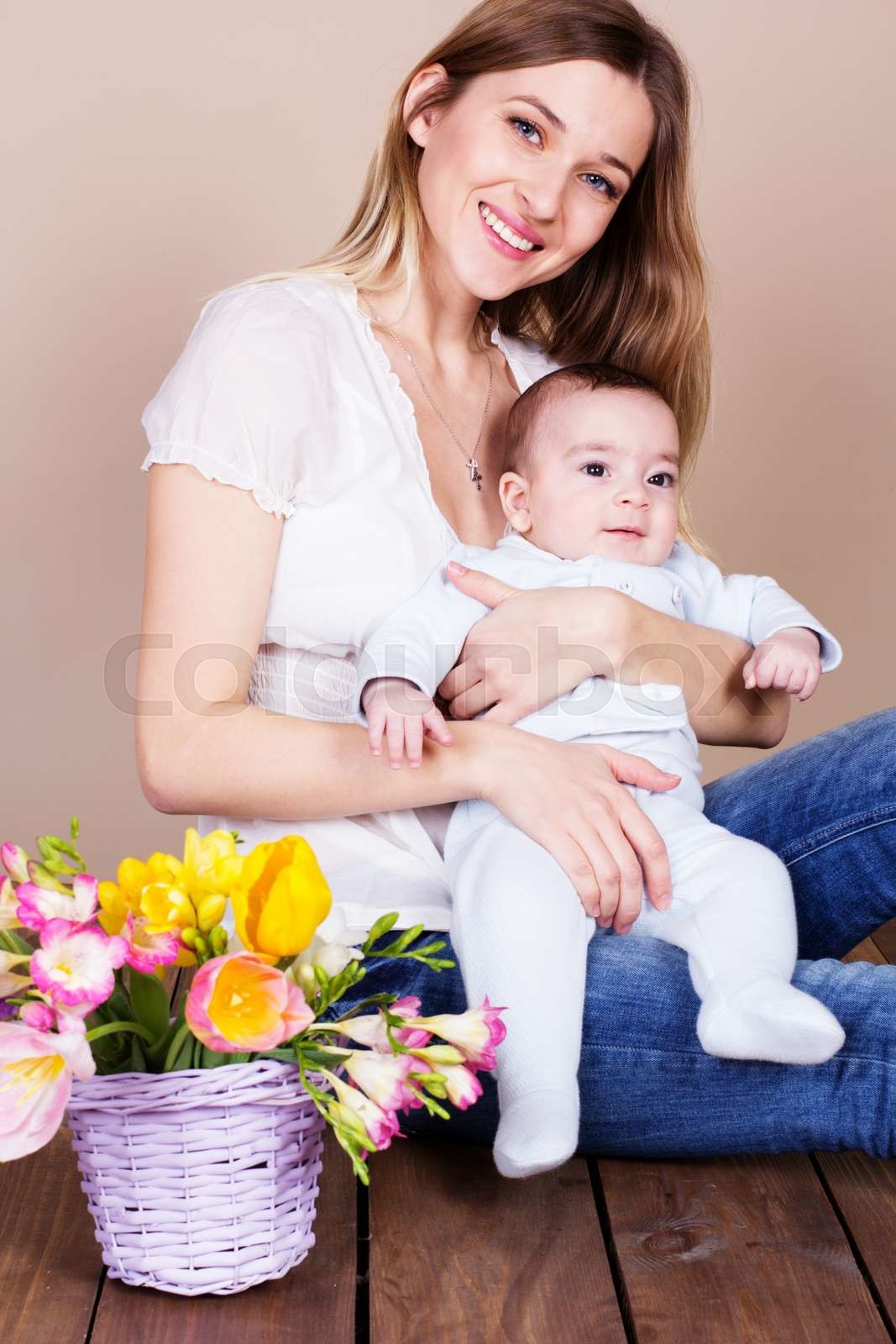 Pretty mom with baby boy in studio | Stock image | Colourbox