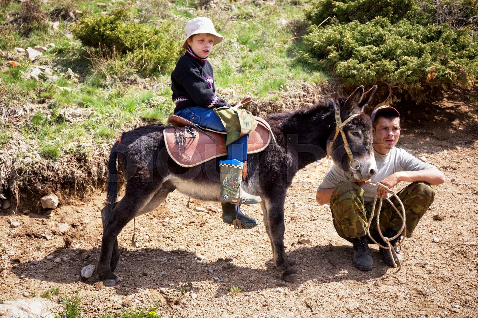 Boy rides a donkey | Stock image | Colourbox