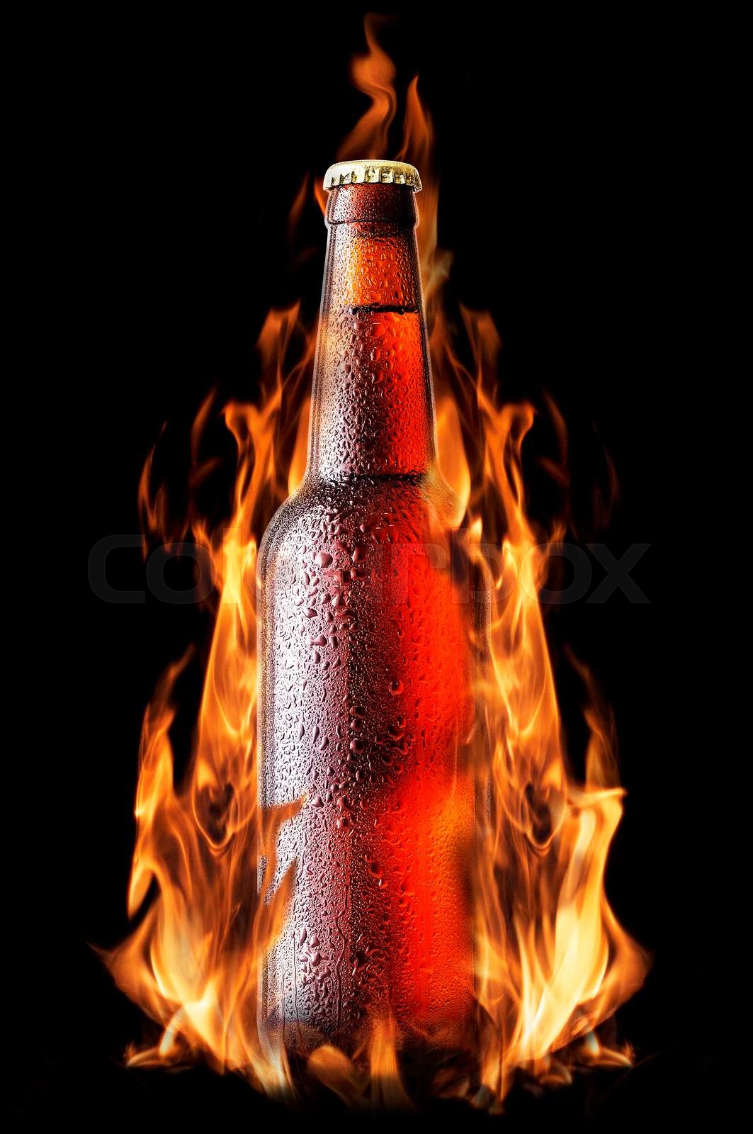 Brown beer bottle in the fire | Stock image | Colourbox