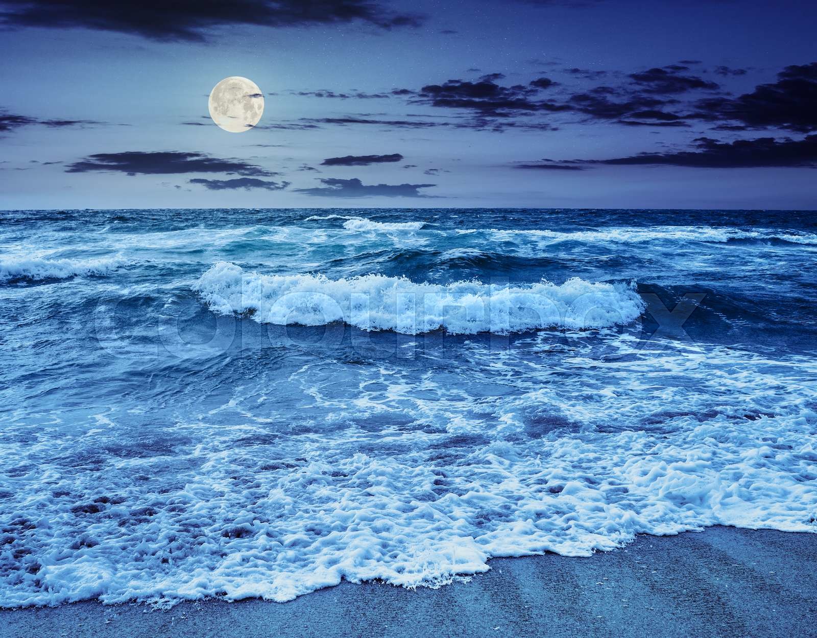 sea waves crashing on sandy beach at night | Stock image | Colourbox