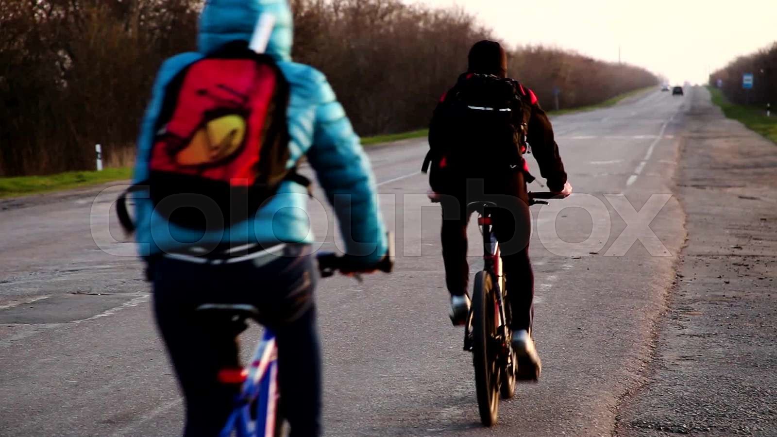 Cyclist riding a bike on an open road to the sunset | Stock video ...
