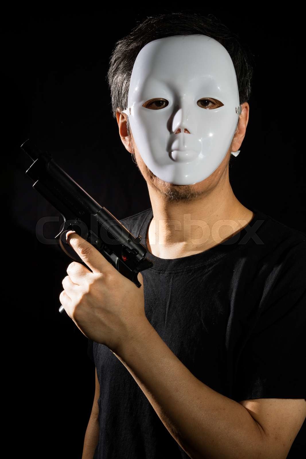 Man in a Mask with a Gun | Stock image | Colourbox