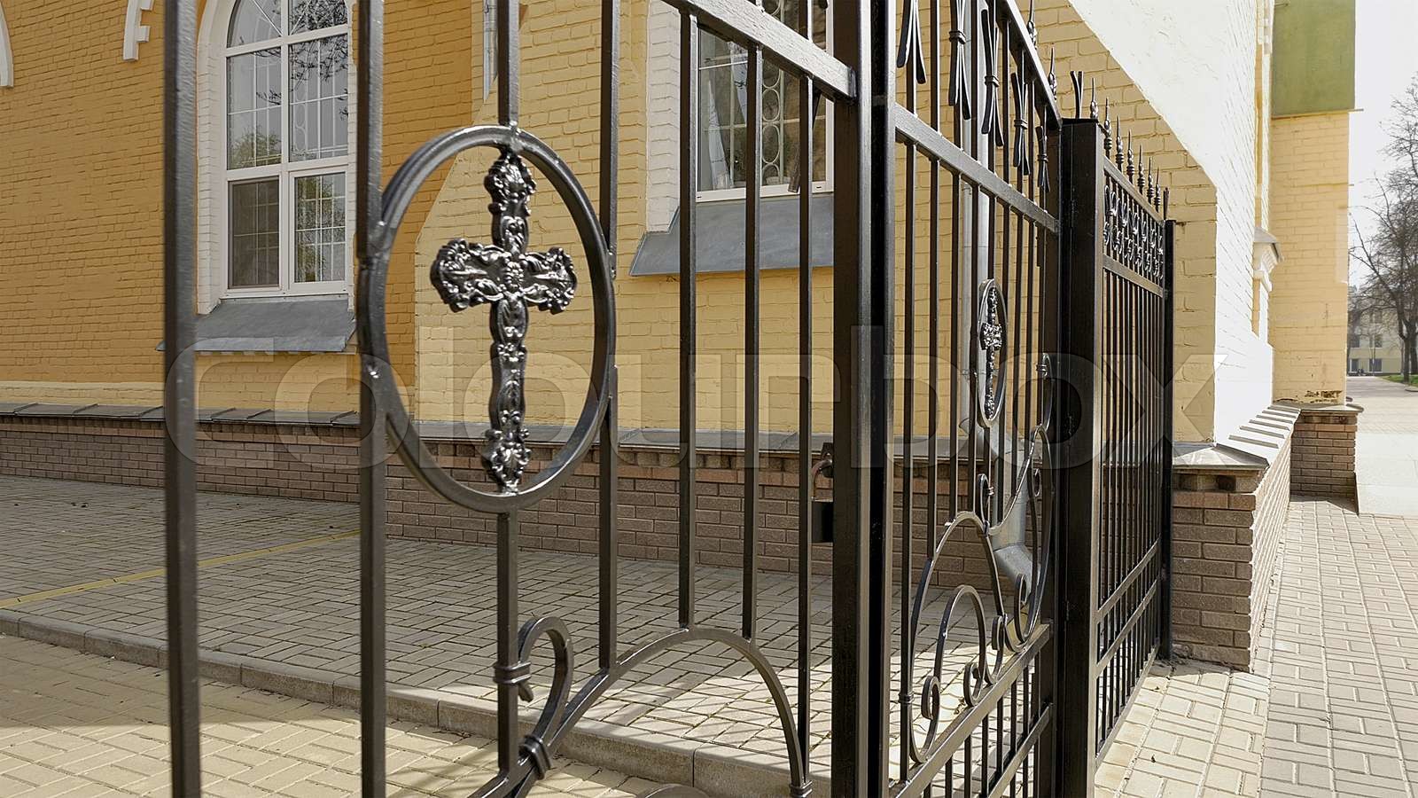 Metal fence and gate with cross of the churchyard | Stock image | Colourbox