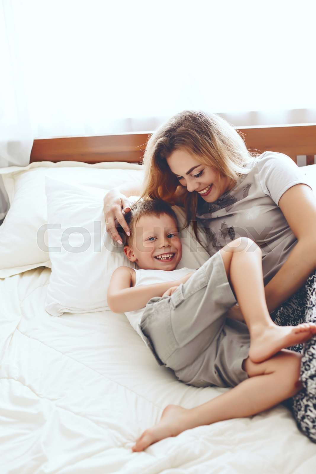 Mother Plays With Son In Bed Stock Image Colourbox