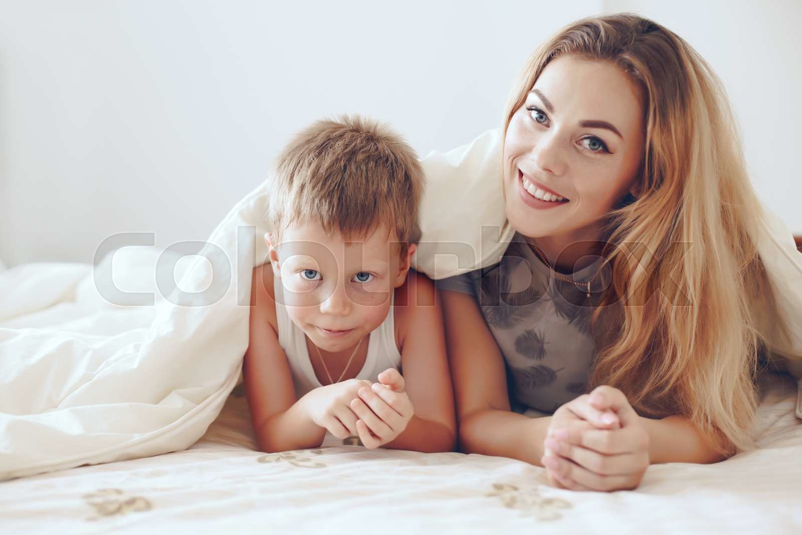 Mother Plays With Son In Bed Stock Image Colourbox