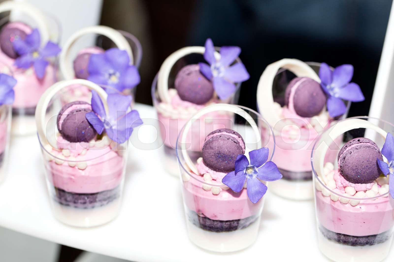 mini canapes in plastic cups decorated with edible flowers | Stock ...
