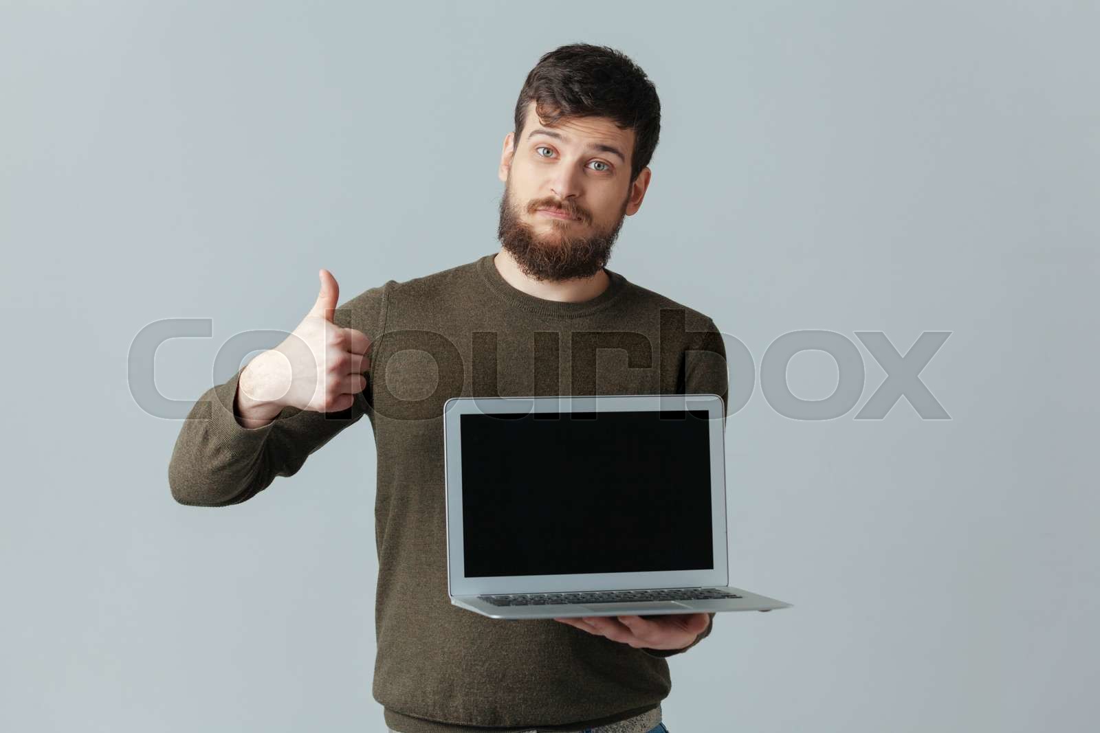 Man showing blank laptop computer screen and thumb up | Stock image ...