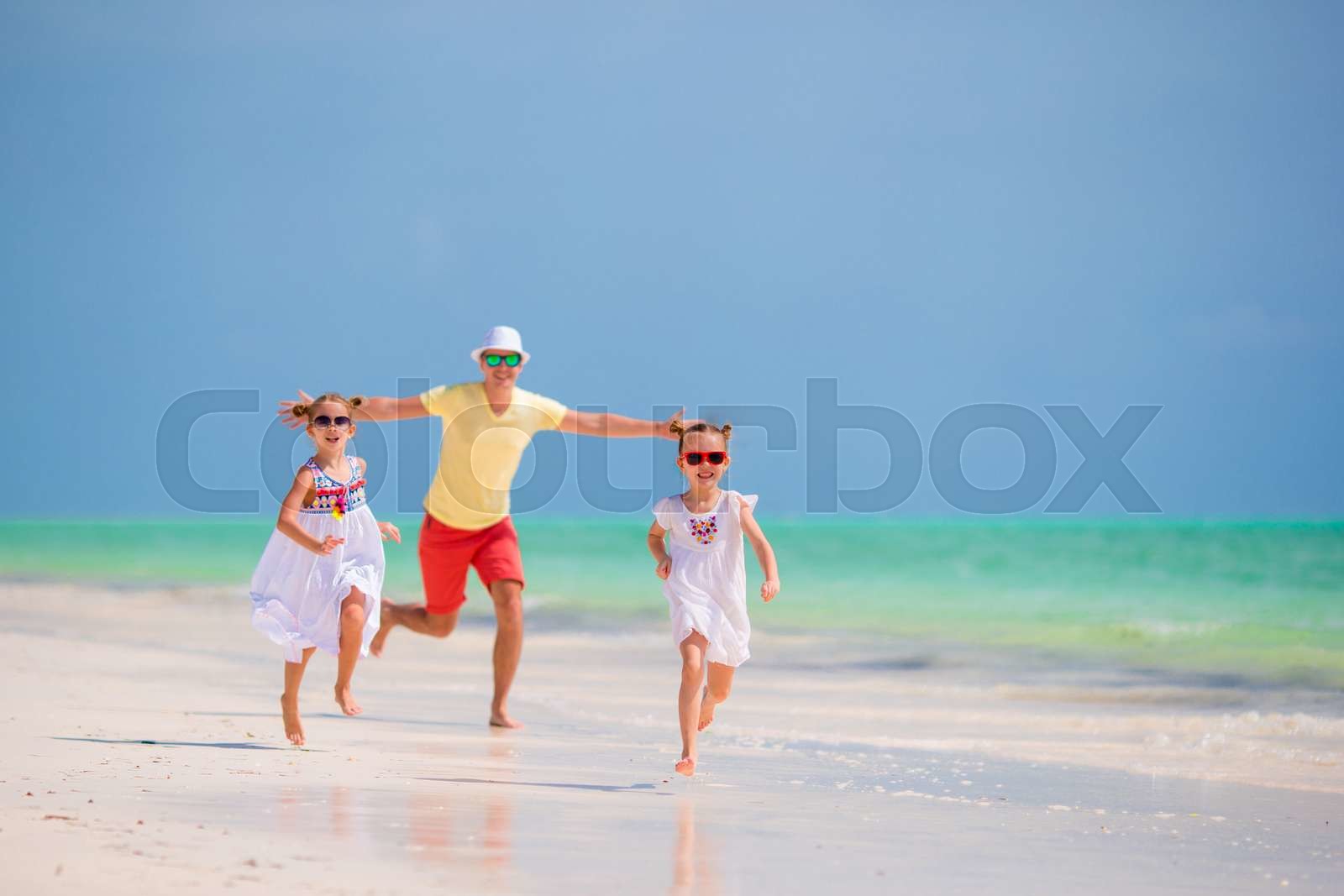 Happy family at tropical beach having fun | Stock image | Colourbox