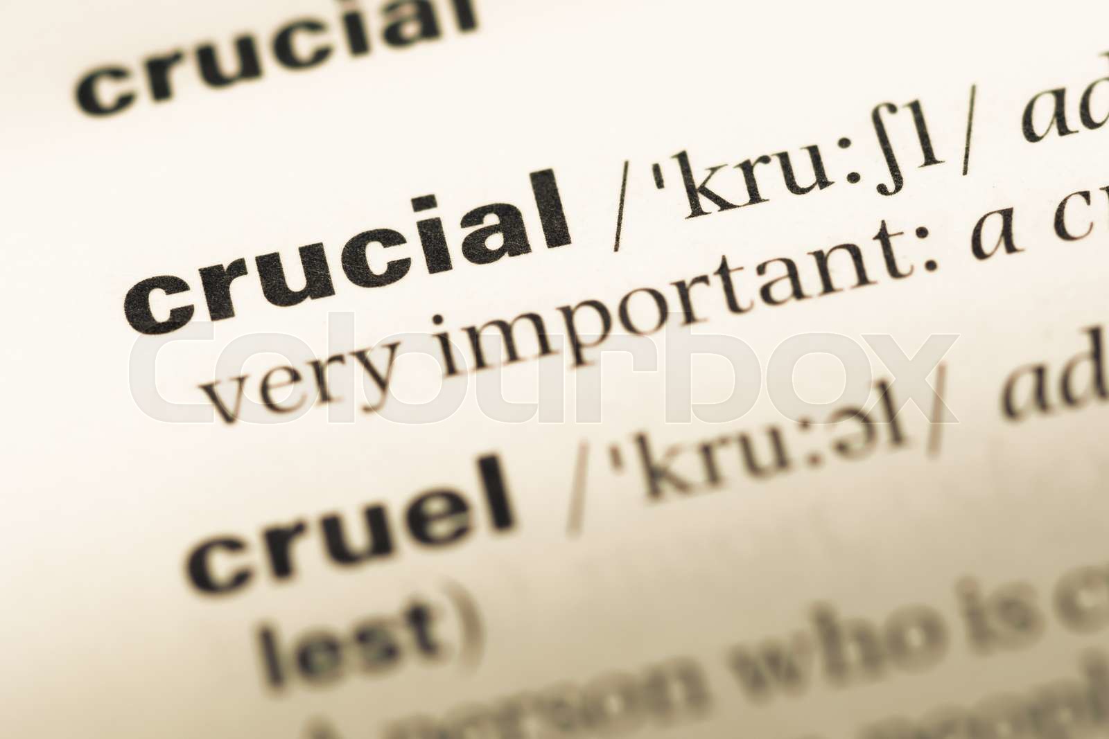 Close up of old English dictionary page with word crucial. | Stock ...
