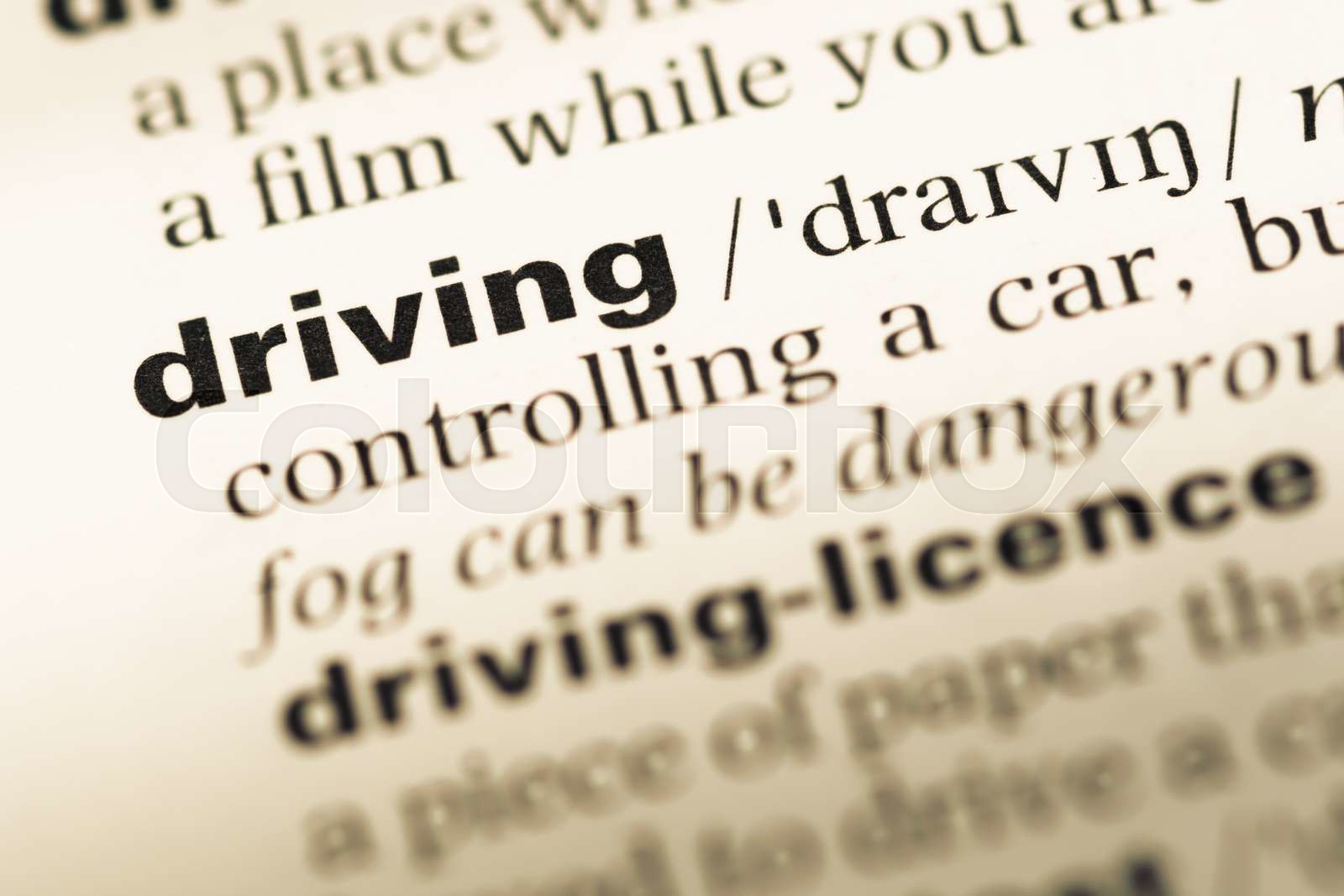 Close up of old English dictionary page with word driving. | Stock ...