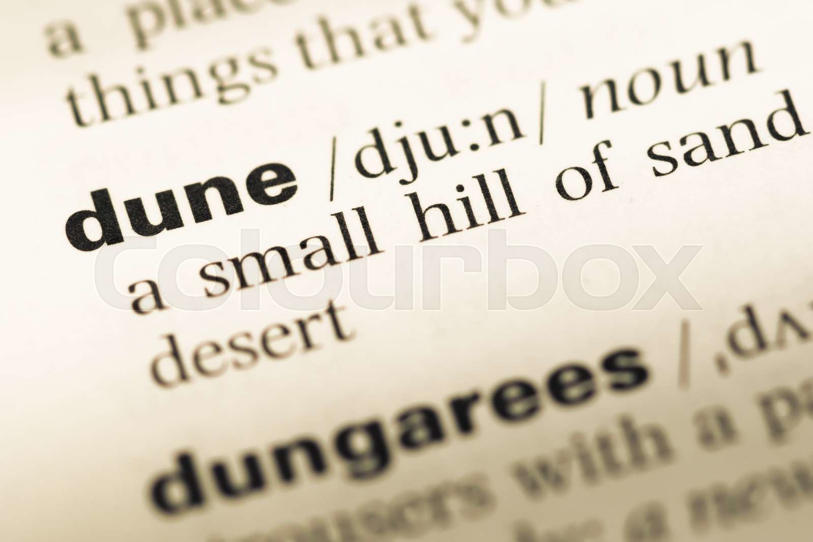 Close up of old English dictionary page with word dune. | Stock image | Colourbox