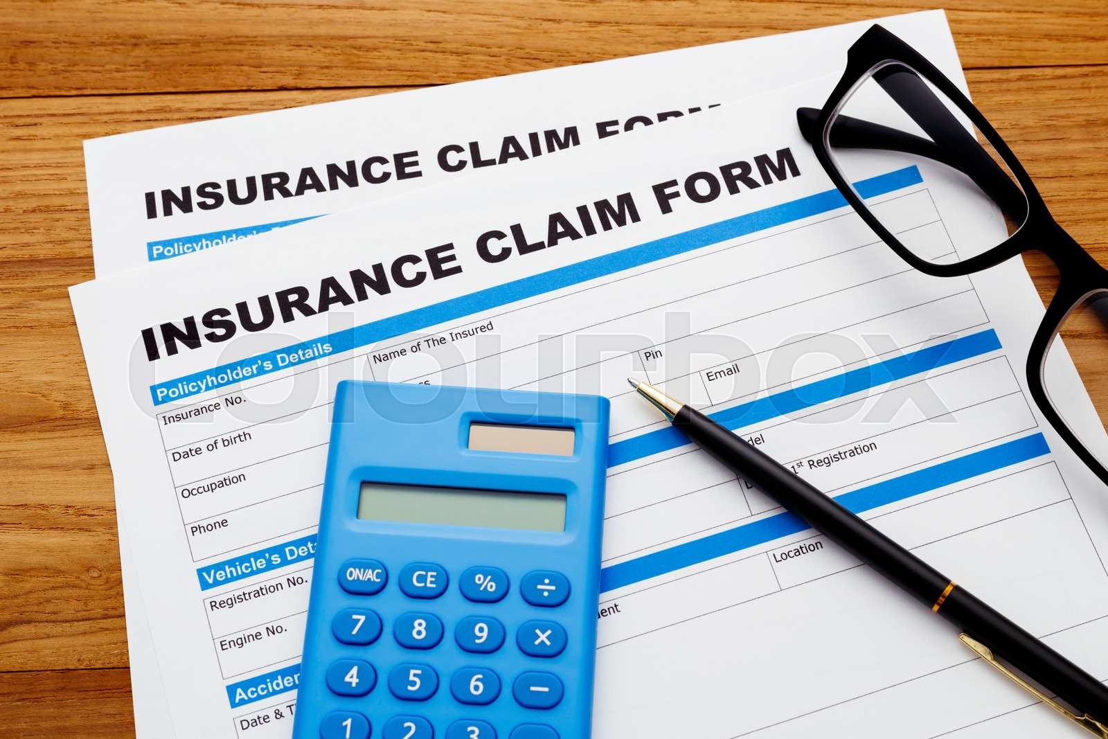 Insurance claim form with calculator | Stock image | Colourbox