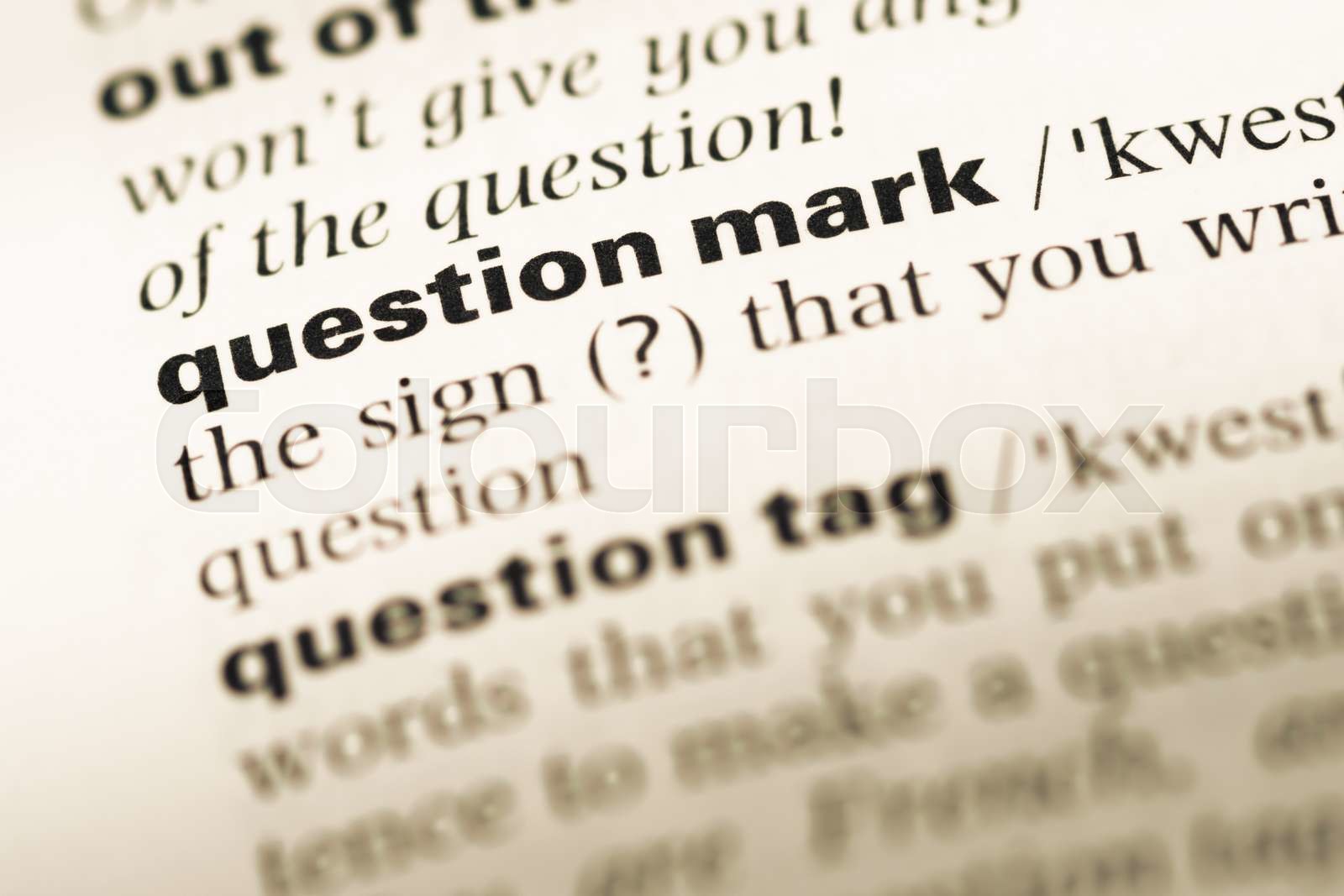 Close up of old English dictionary page with word question mark ...